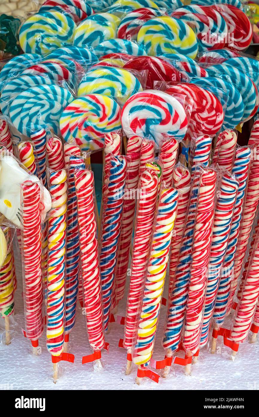 Spiral colorful lollipop candy sticks sold on market fair Stock Photo ...