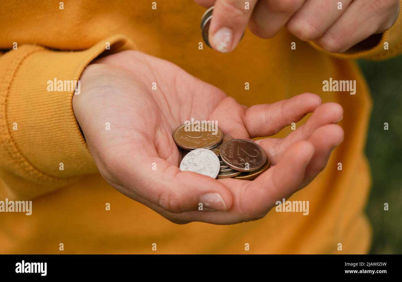 Russian woman considers savings cash. Only mans hands and money, yellow ...