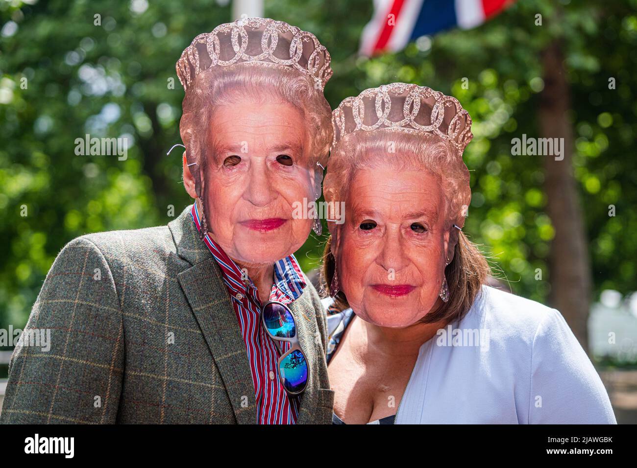 London UK, 1 June 2022. Royal fans wearing Queen Elizabeth masks gather ...
