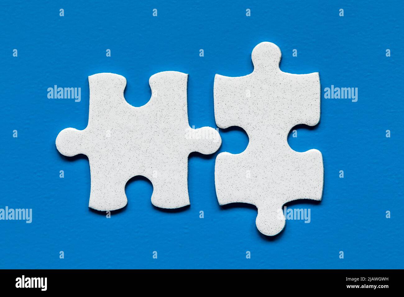White jigsaw puzzle. White puzzle pieces on color background. Unfinished white jigsaw puzzle ...