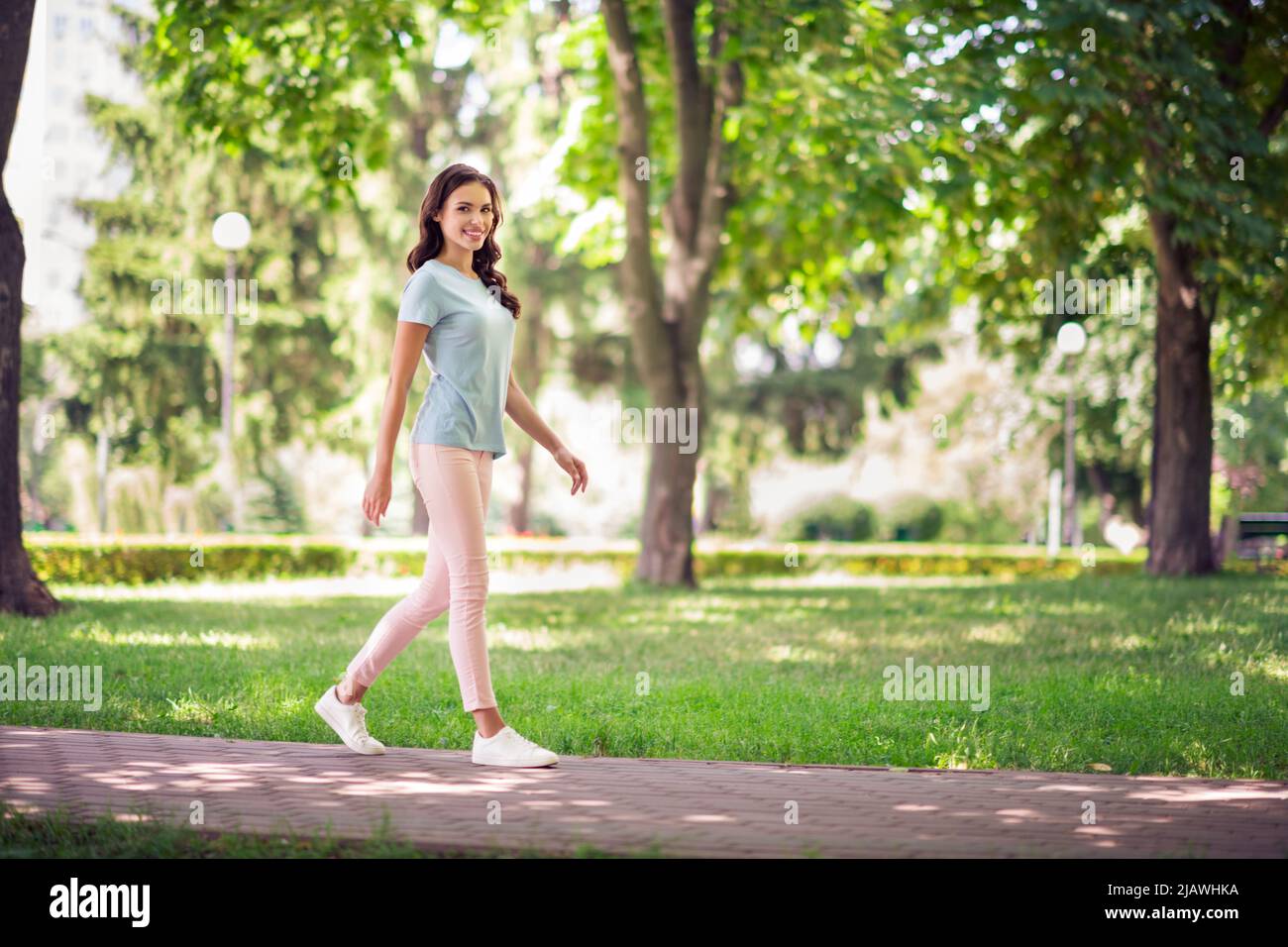 Full length photo of cheerful young attractive pretty woman smile go ...
