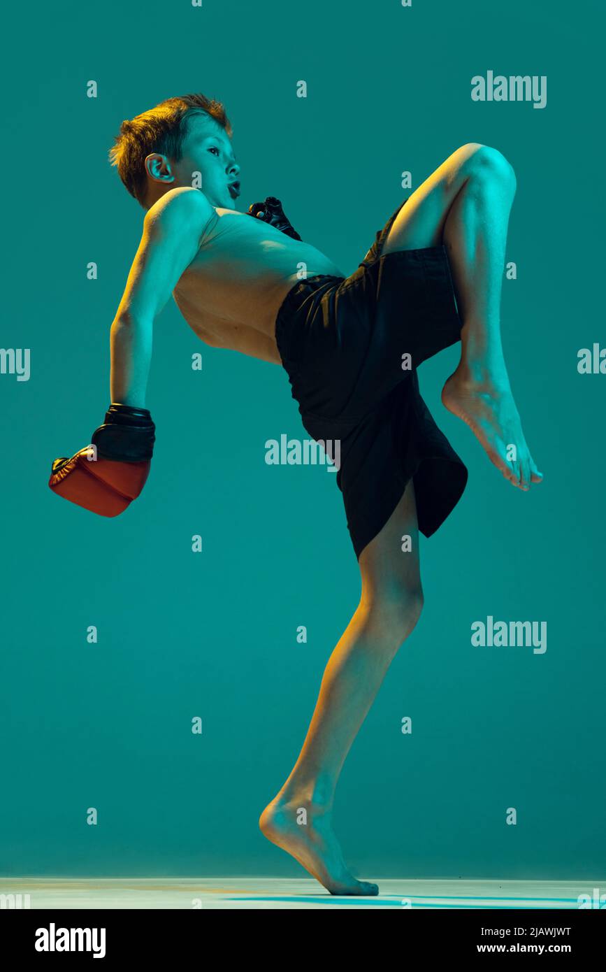 Young sportsmen, beginner fighter of mma sport in action isolated on ...