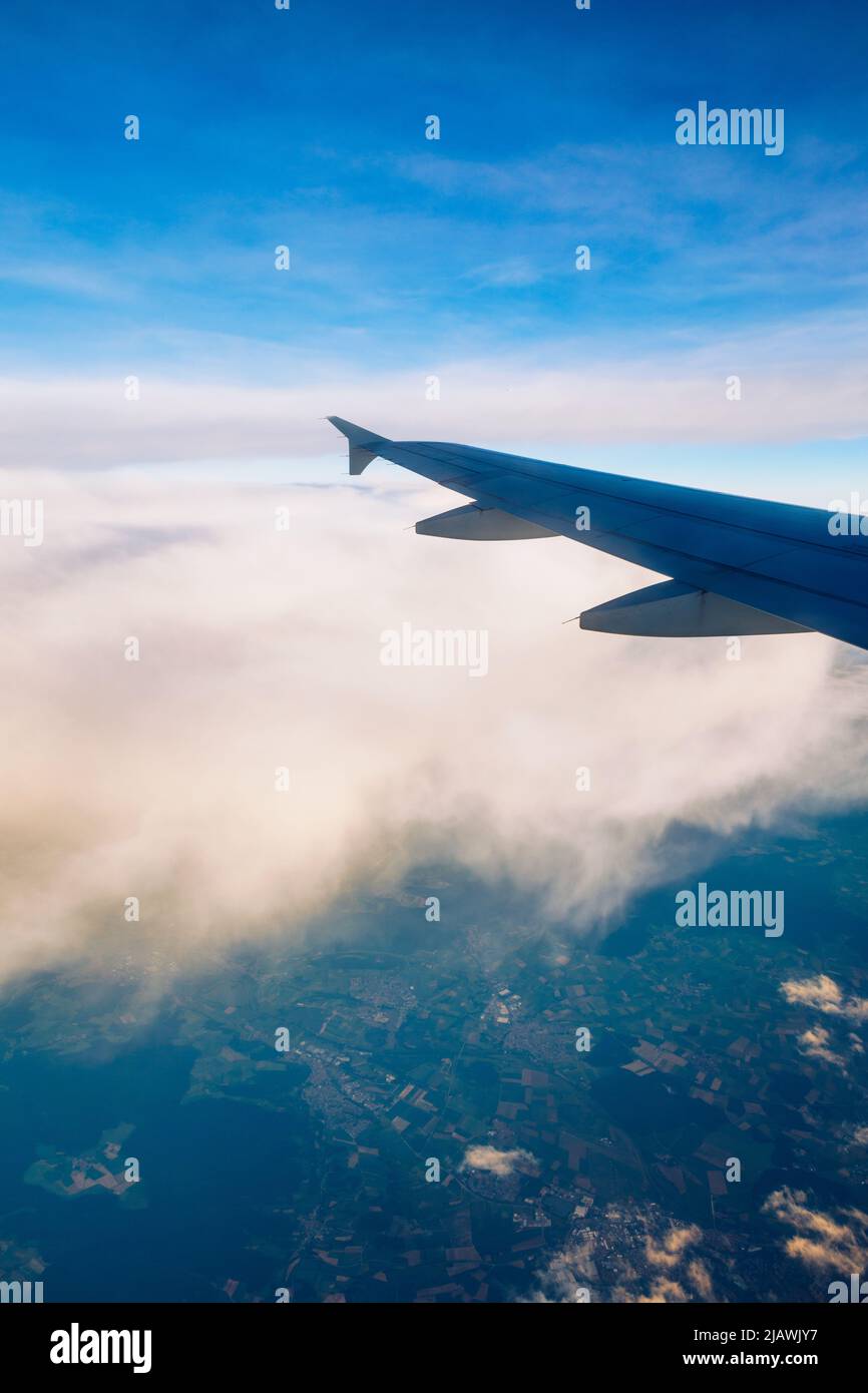 Flying and traveling, view from airplane window on the wing on sunset ...