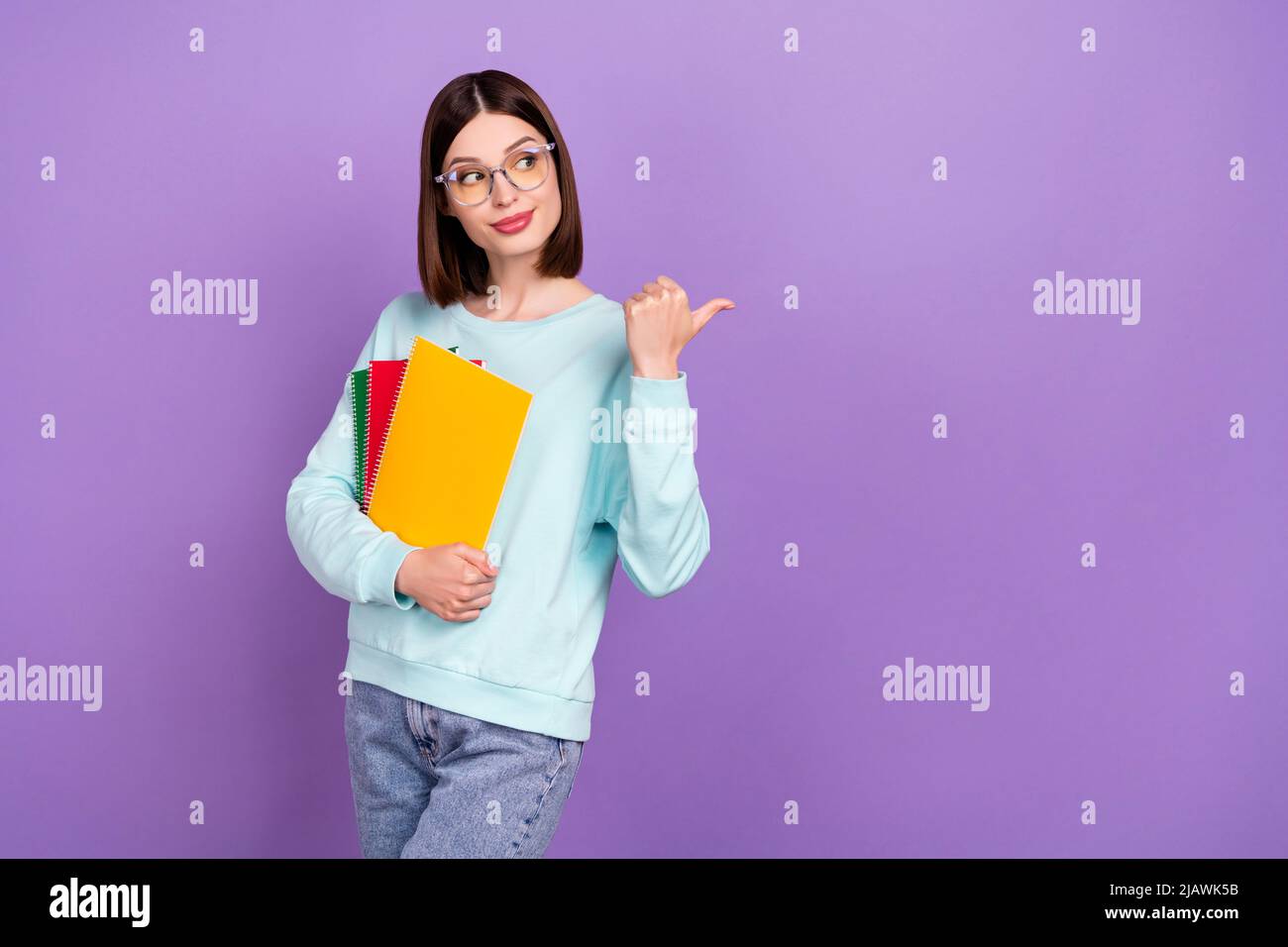Photo portrait girl keeping book pile showing copyspace thumb isolated ...