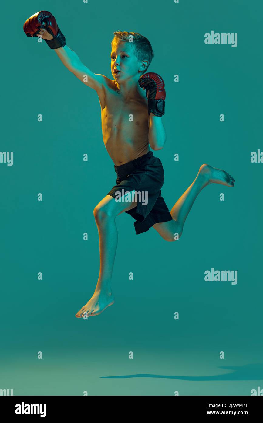 Young sportsmen, beginner fighter of mma sport in action isolated on ...