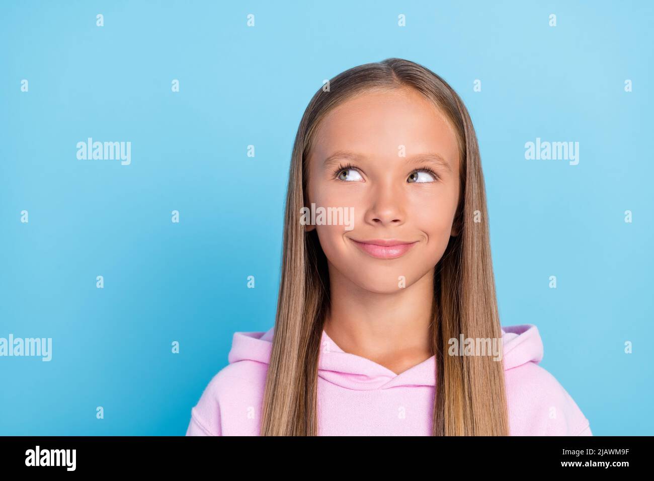 Photo of dreamy pretty young little girl look empty space imagine enjoy ...
