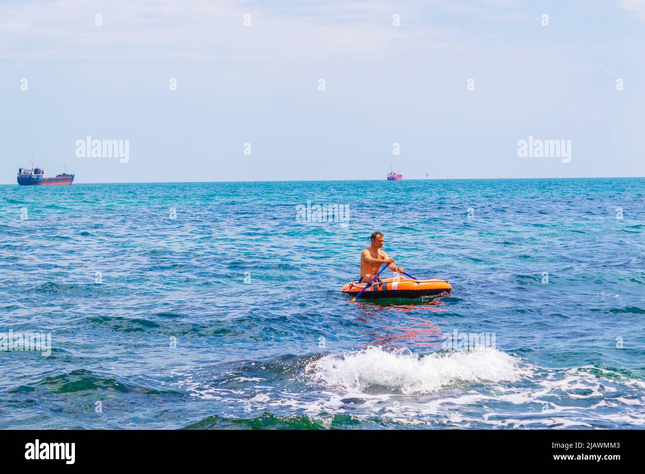 Vacationer man having fun rowing inflatable boat in Black Sea,Varna ...