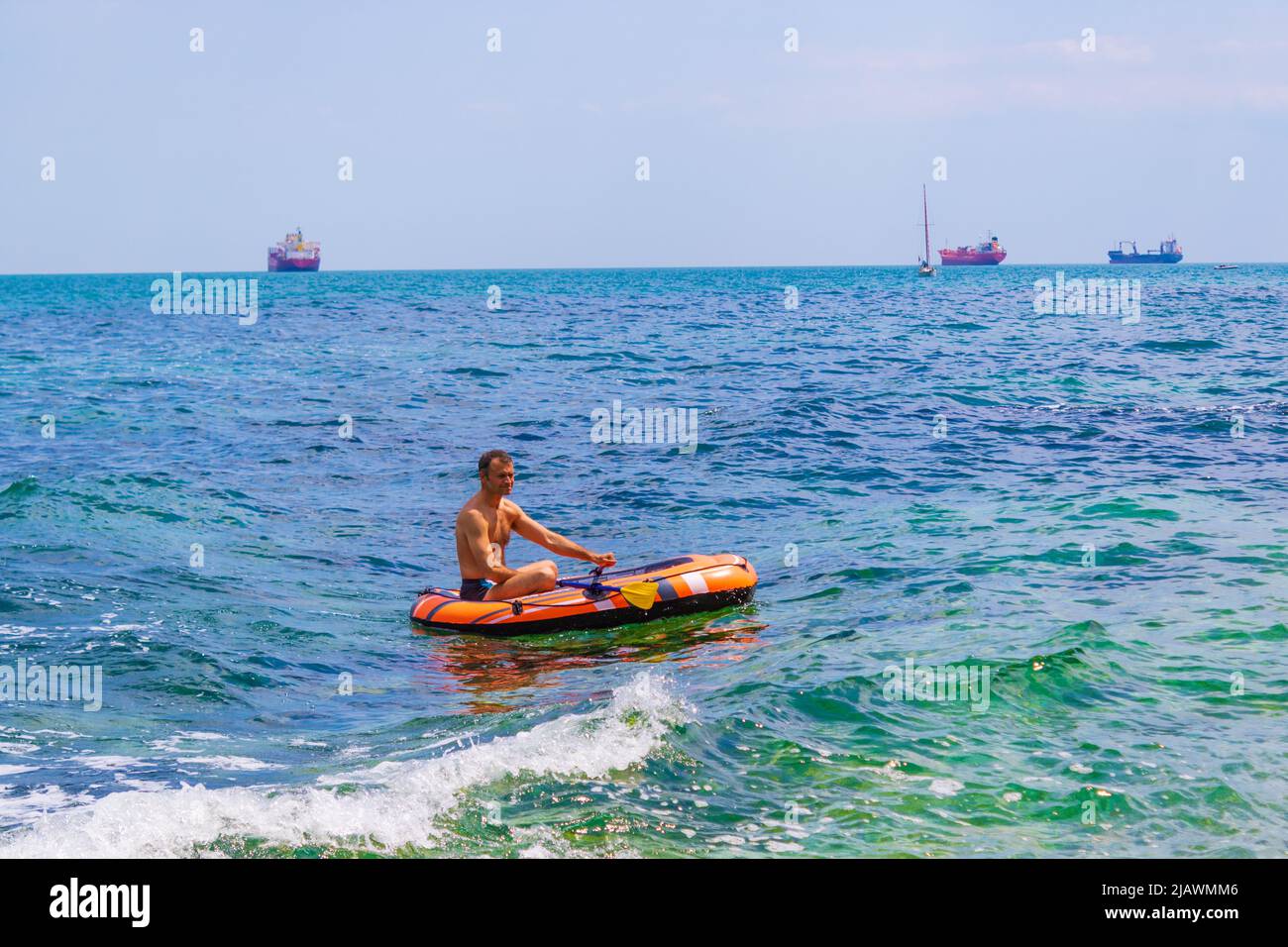 Vacationer man having fun rowing inflatable boat in Black Sea,Varna ...