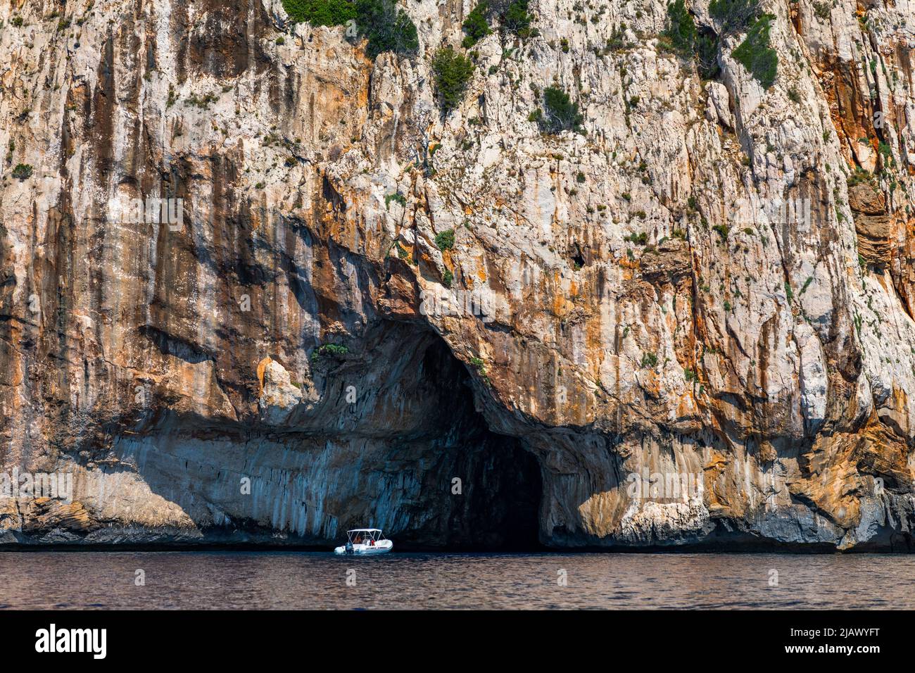 Blue sea and the characteristic caves of Cala Luna, a beach in the ...