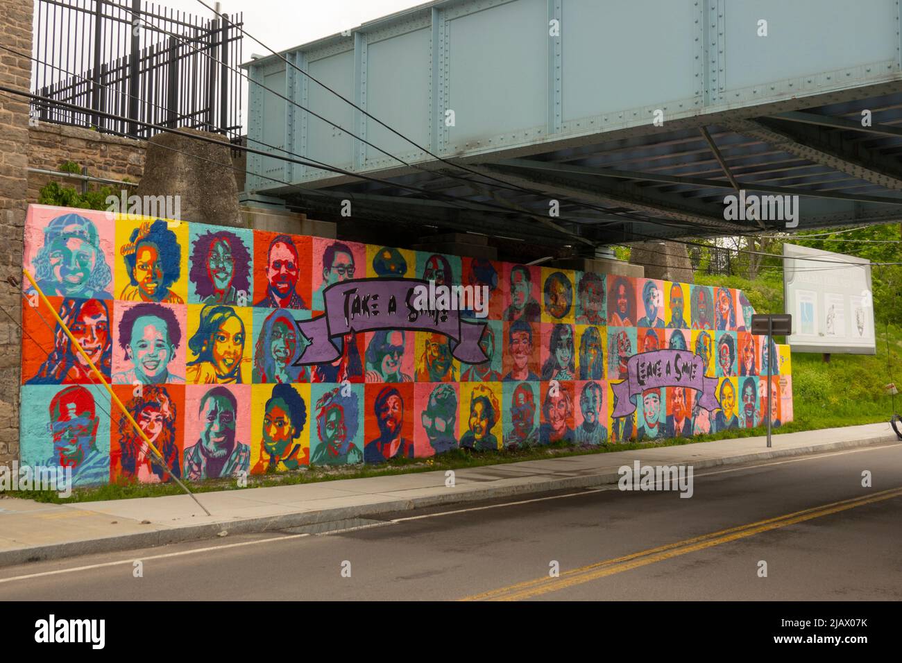 public art mural project of local community people on a wall underneath ...