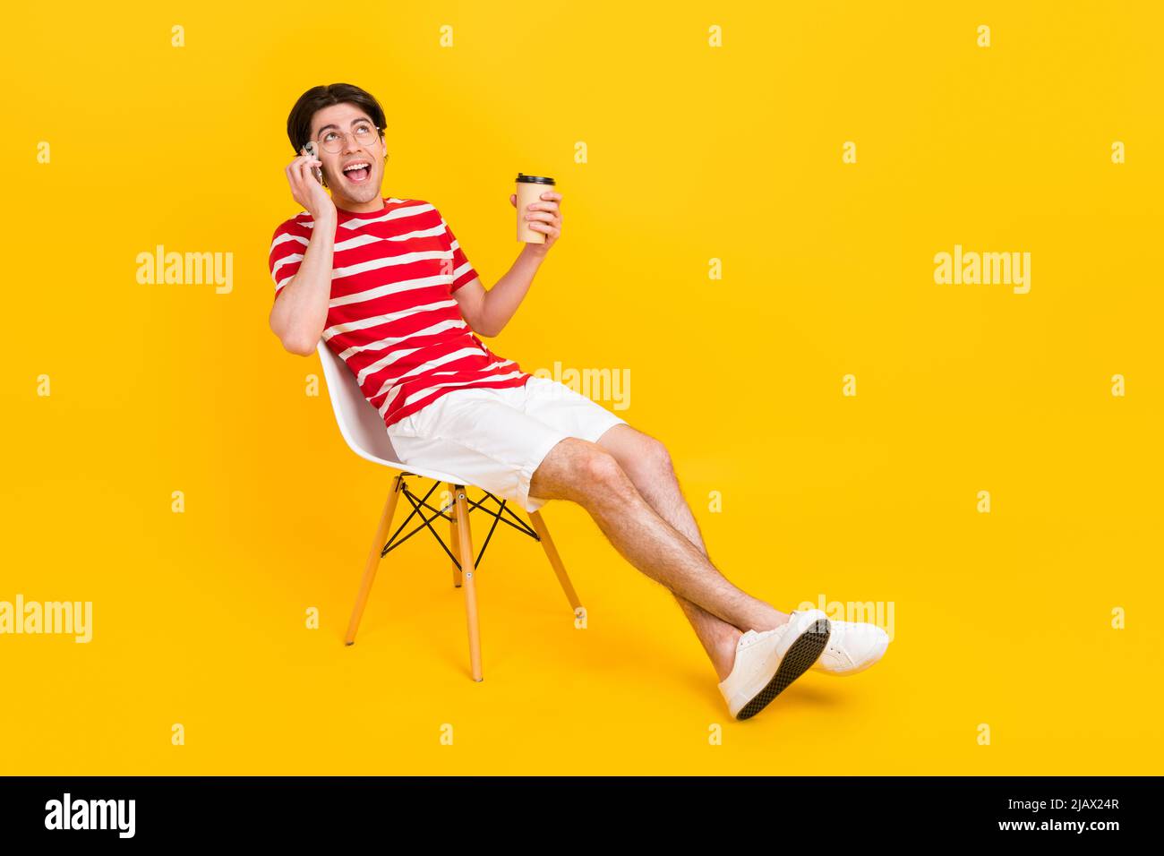 Photo of laughing excited man wear spectacles sitting talking modern ...