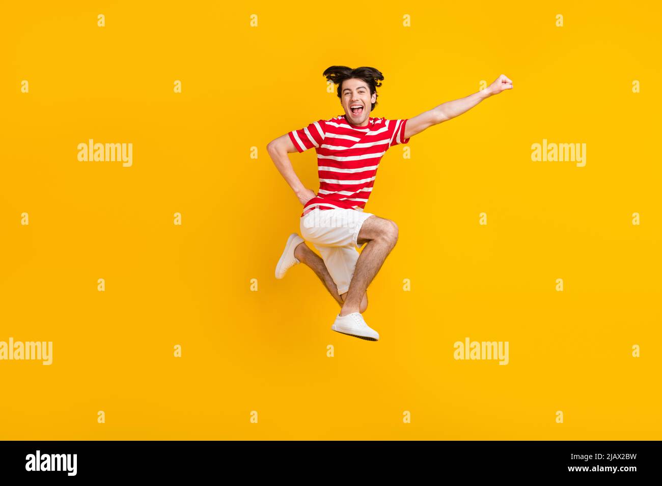 Full body photo of happy joyful young raise hand super hero jump up ...