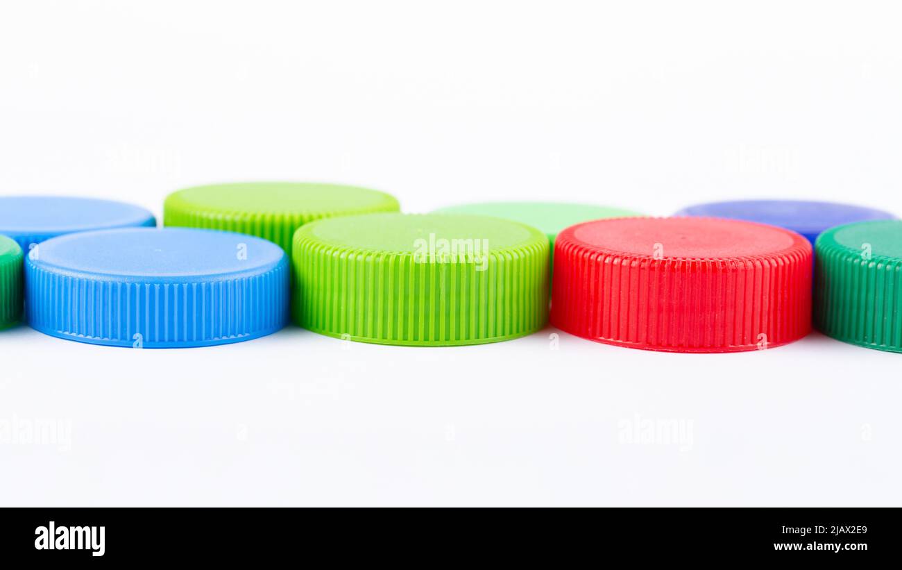 Pile of colored plastic caps on white background. Recycling concept ...