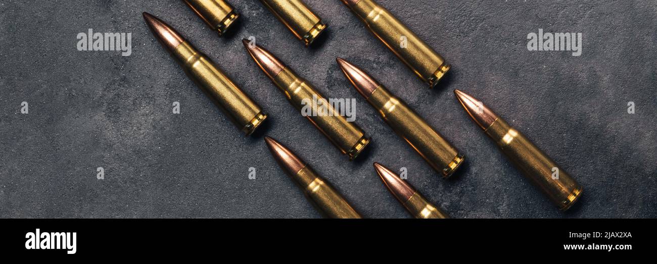 Bullets on gray background banner with copy space. Cartridges 7.62 ...