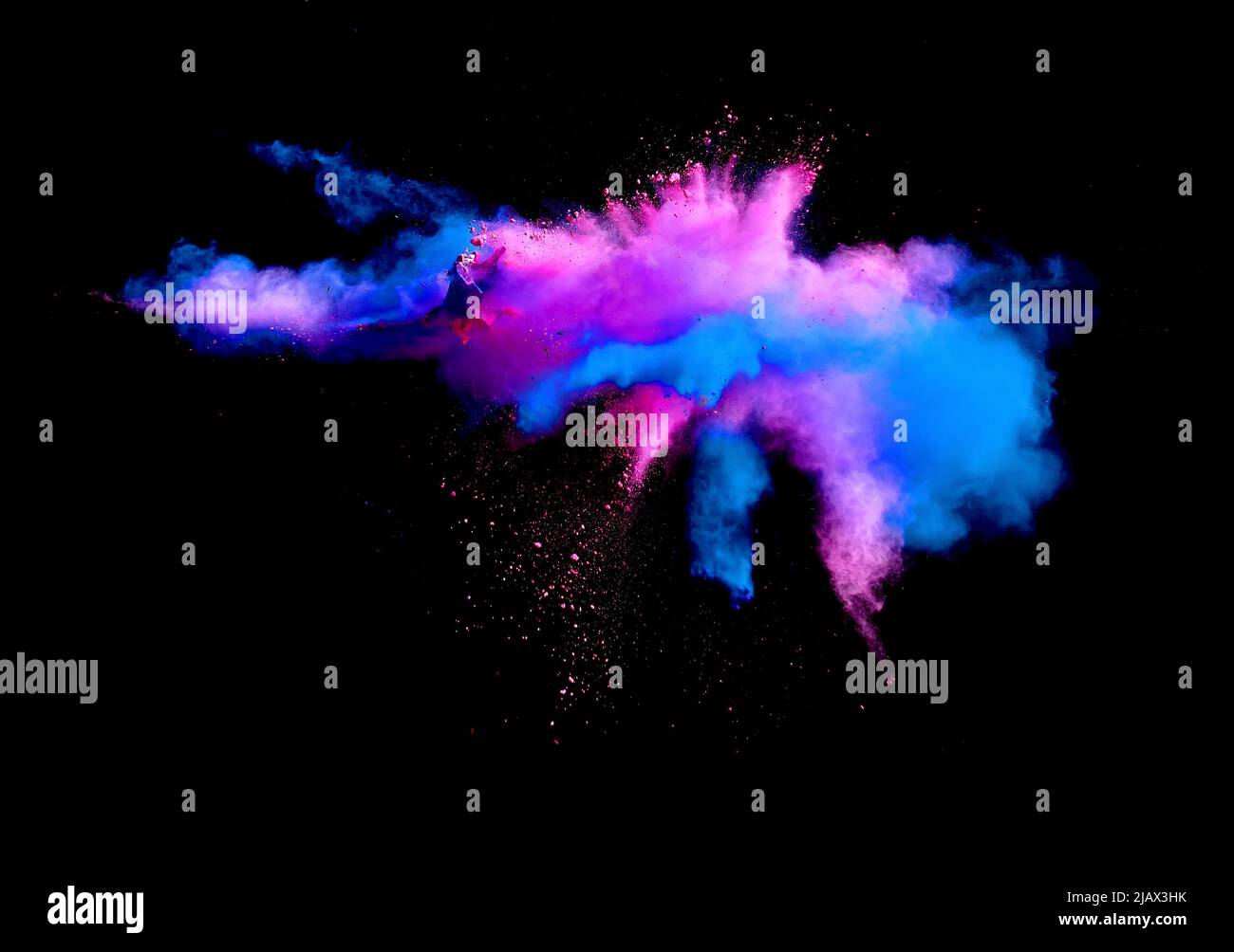 Various multicolored forms of powder paint explode in front of a black ...
