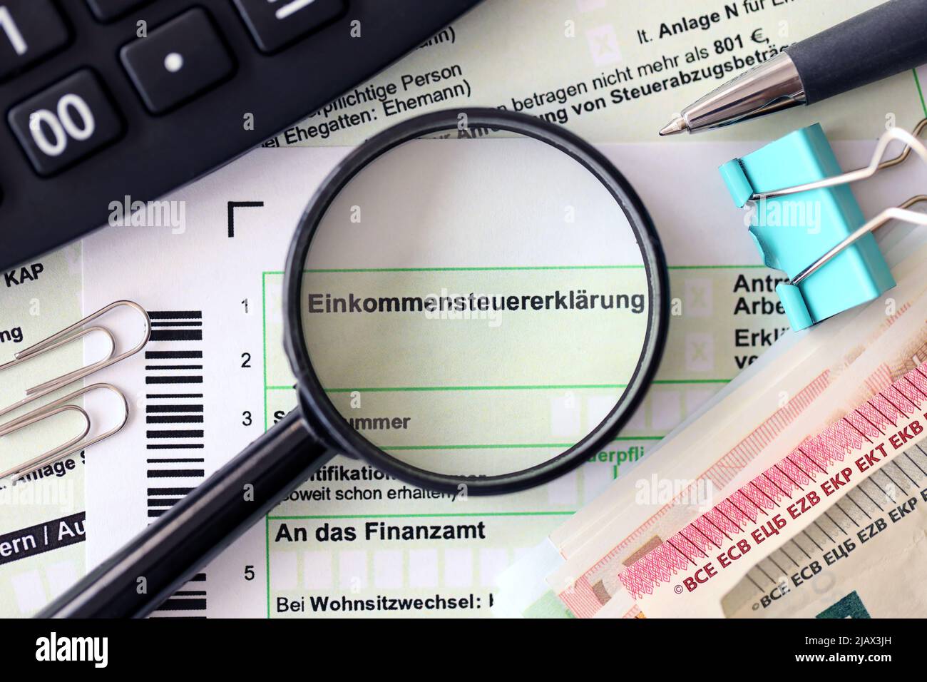 German income tax return form with pen and european euro money bills ...