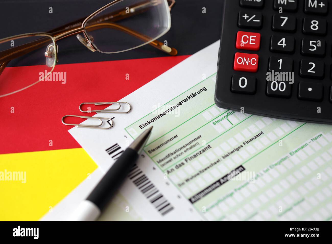 German income tax return form with pen and european euro money bills ...