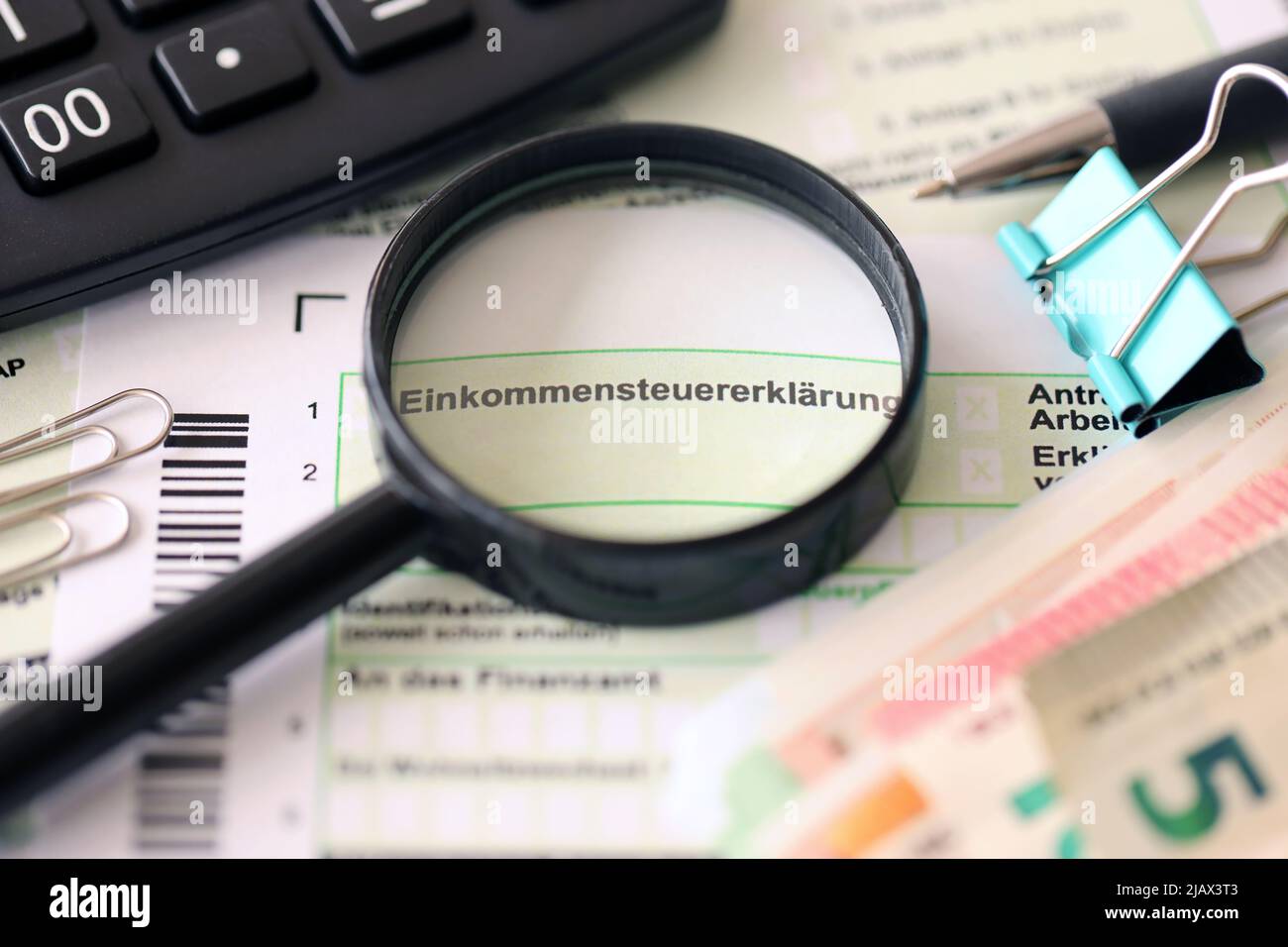 German income tax return form with pen and european euro money bills ...