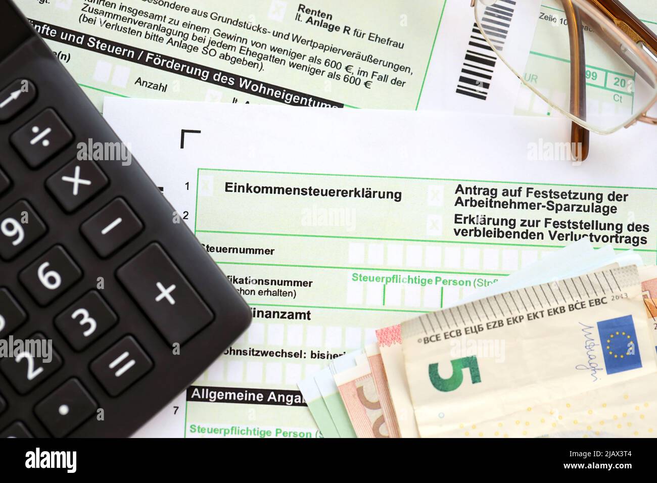 German income tax return form with european euro money bills and ...