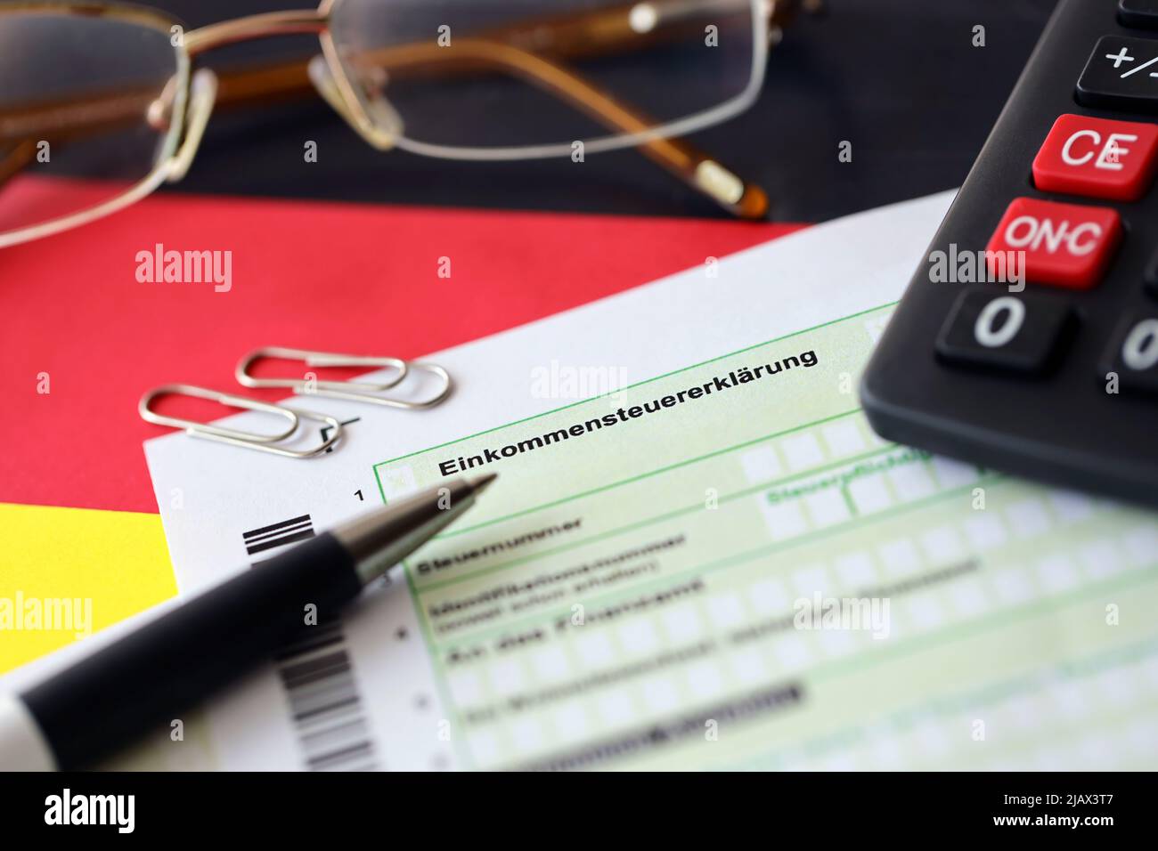 German income tax return form with pen and european euro money bills ...
