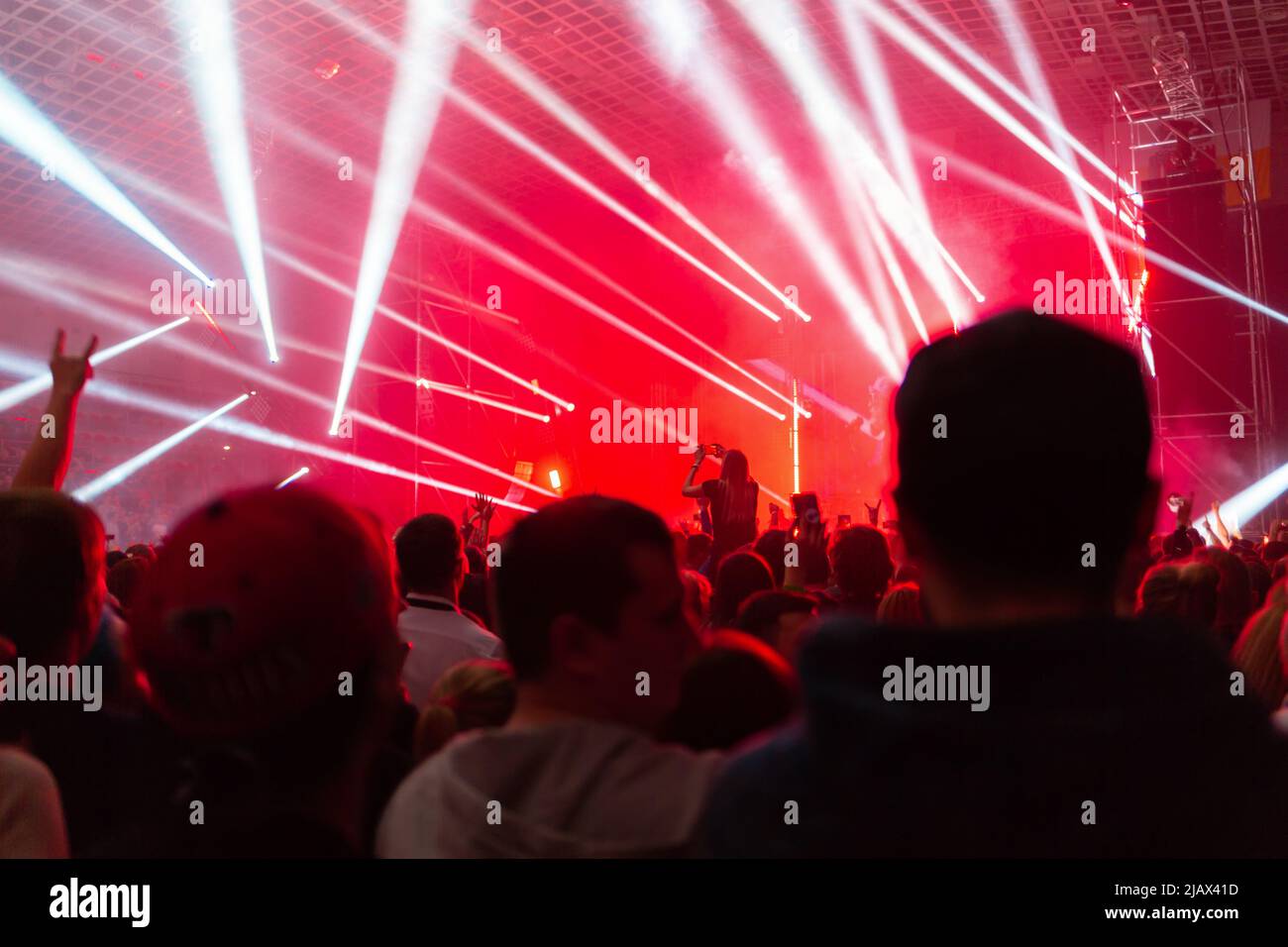 A crowd of people at the concert have fun and dance to the music at the ...