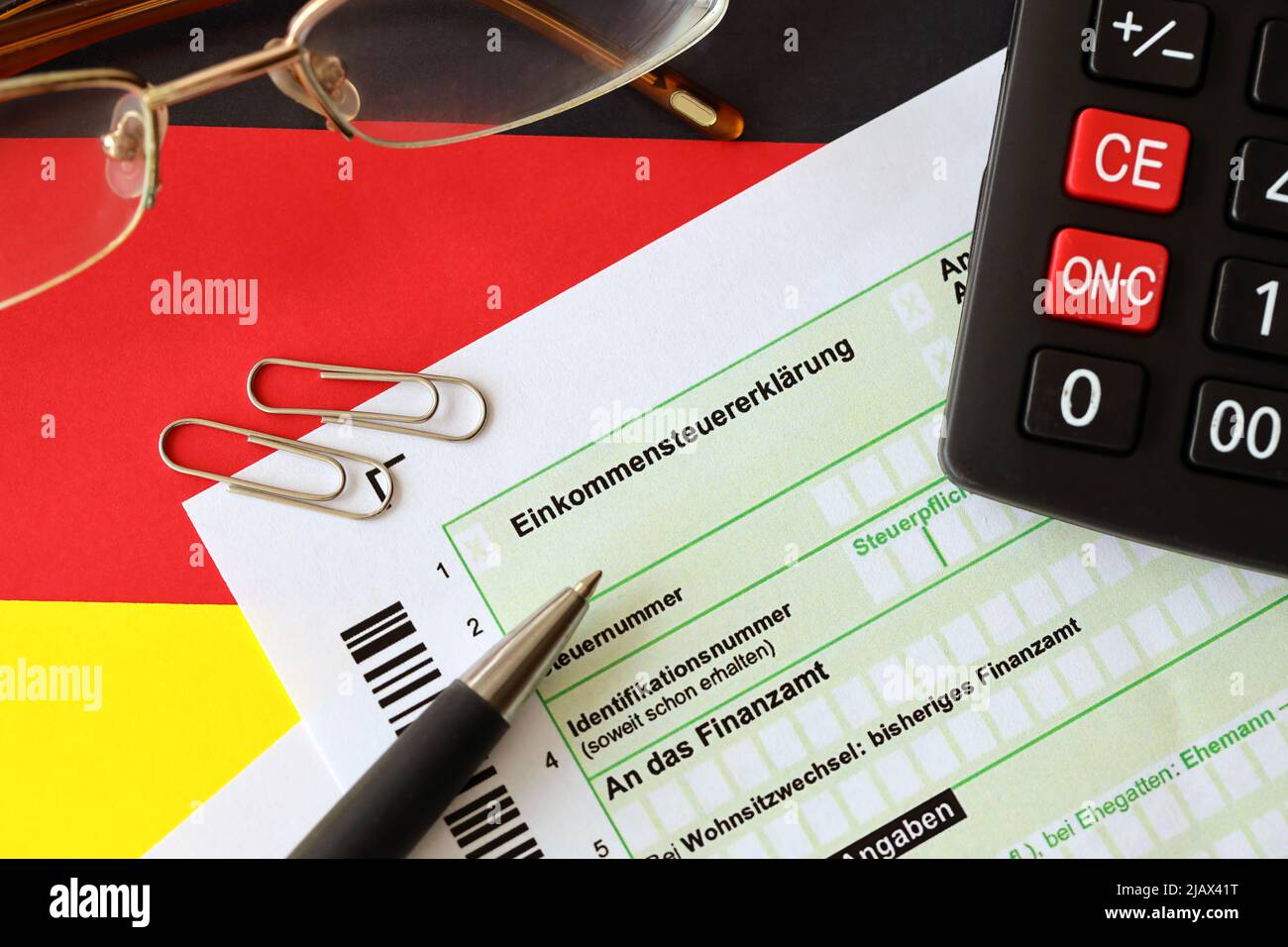 German income tax return form with pen and european euro money bills ...