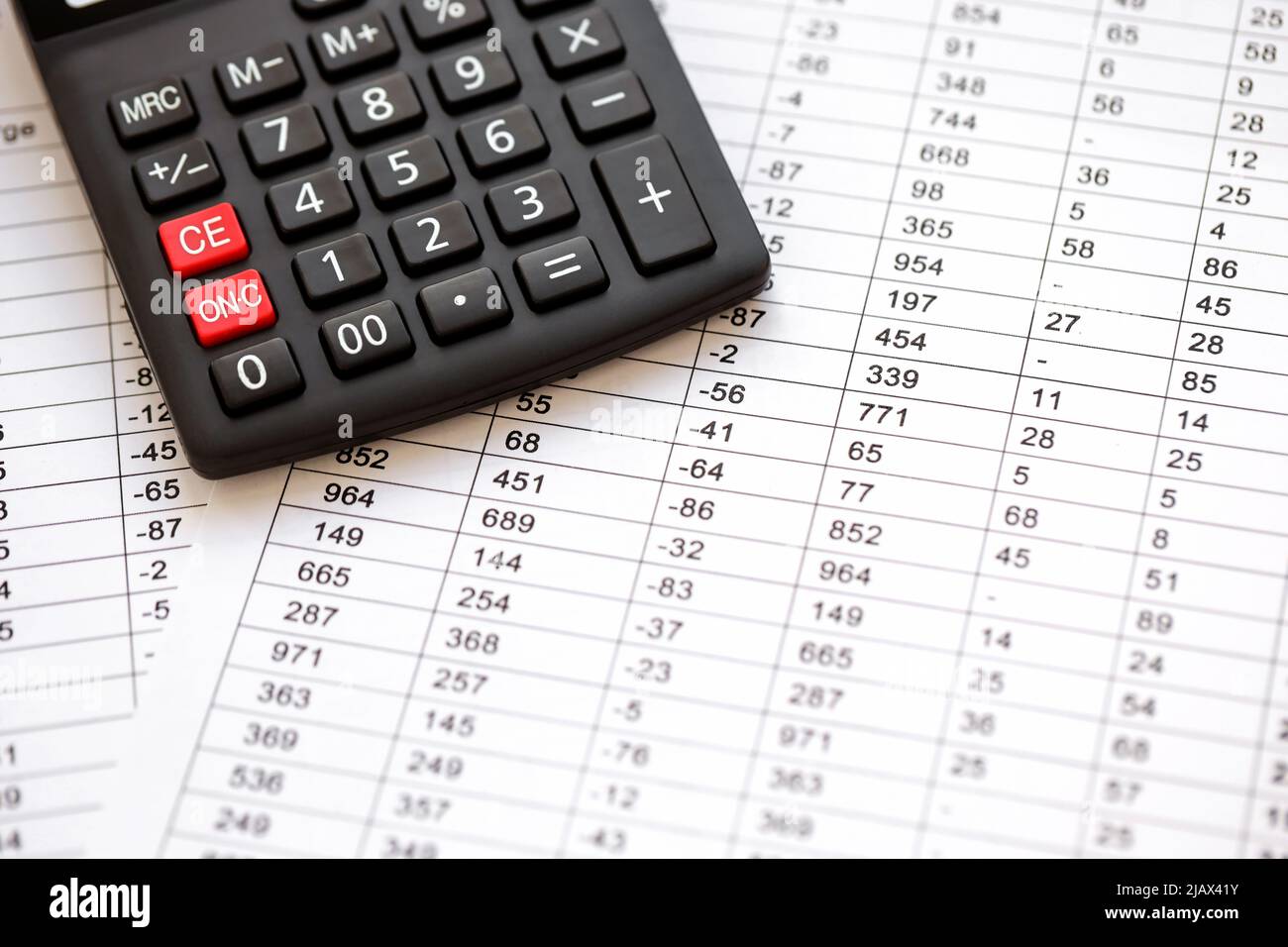Big black calculator lies on financial statement and balance sheeet on ...