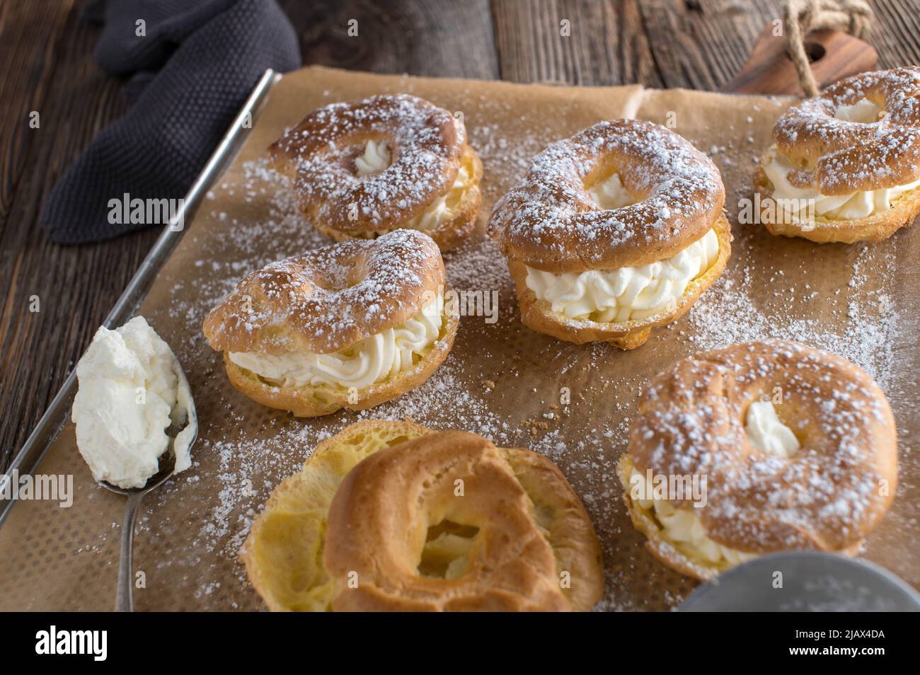 Homemade cream puffs with whipped cream filling on a baking tray Stock ...