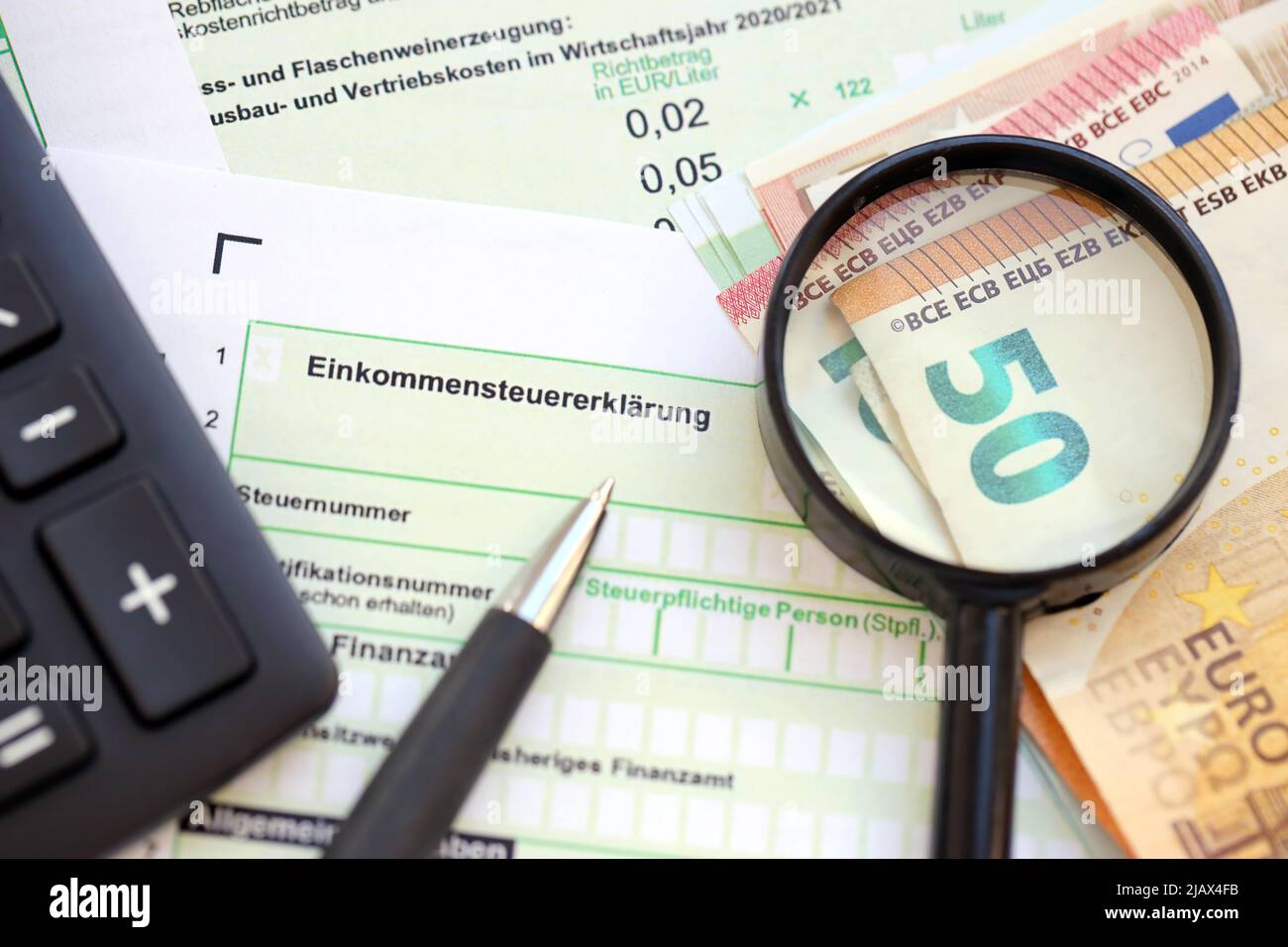 German income tax return form with pen and european euro money bills ...