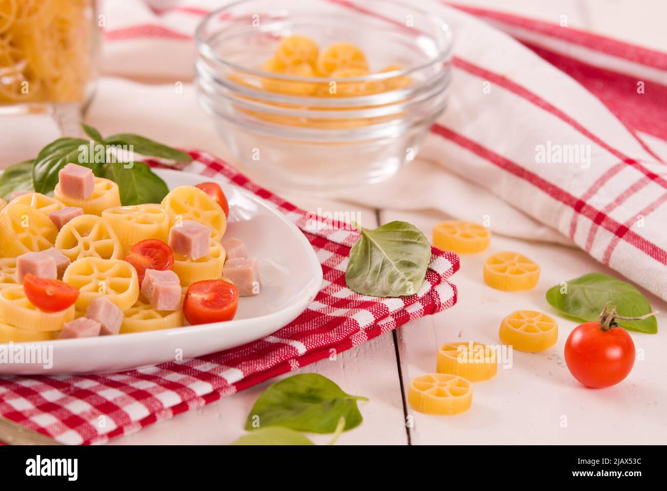 Ruote pasta with tomato and ham Stock Photo - Alamy