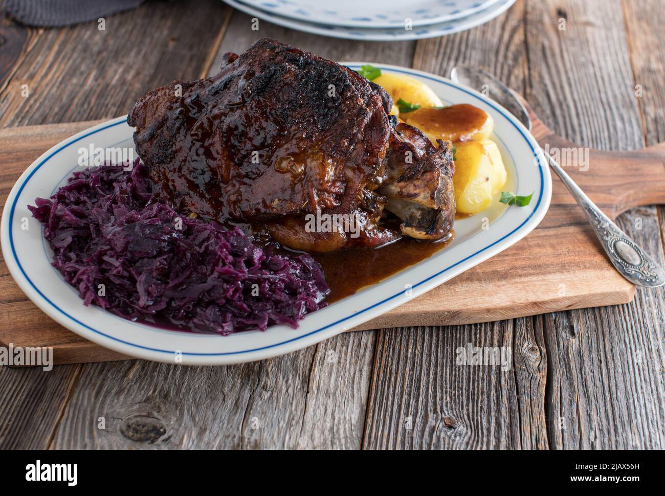 Roast turkey shank with red cabbage, potatoes and gravy Stock Photo - Alamy