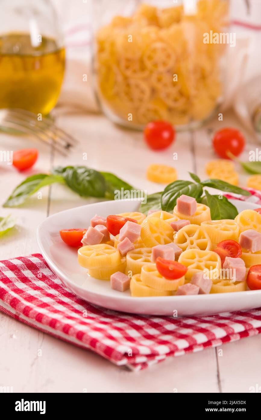 Ruote pasta with tomato and ham Stock Photo - Alamy