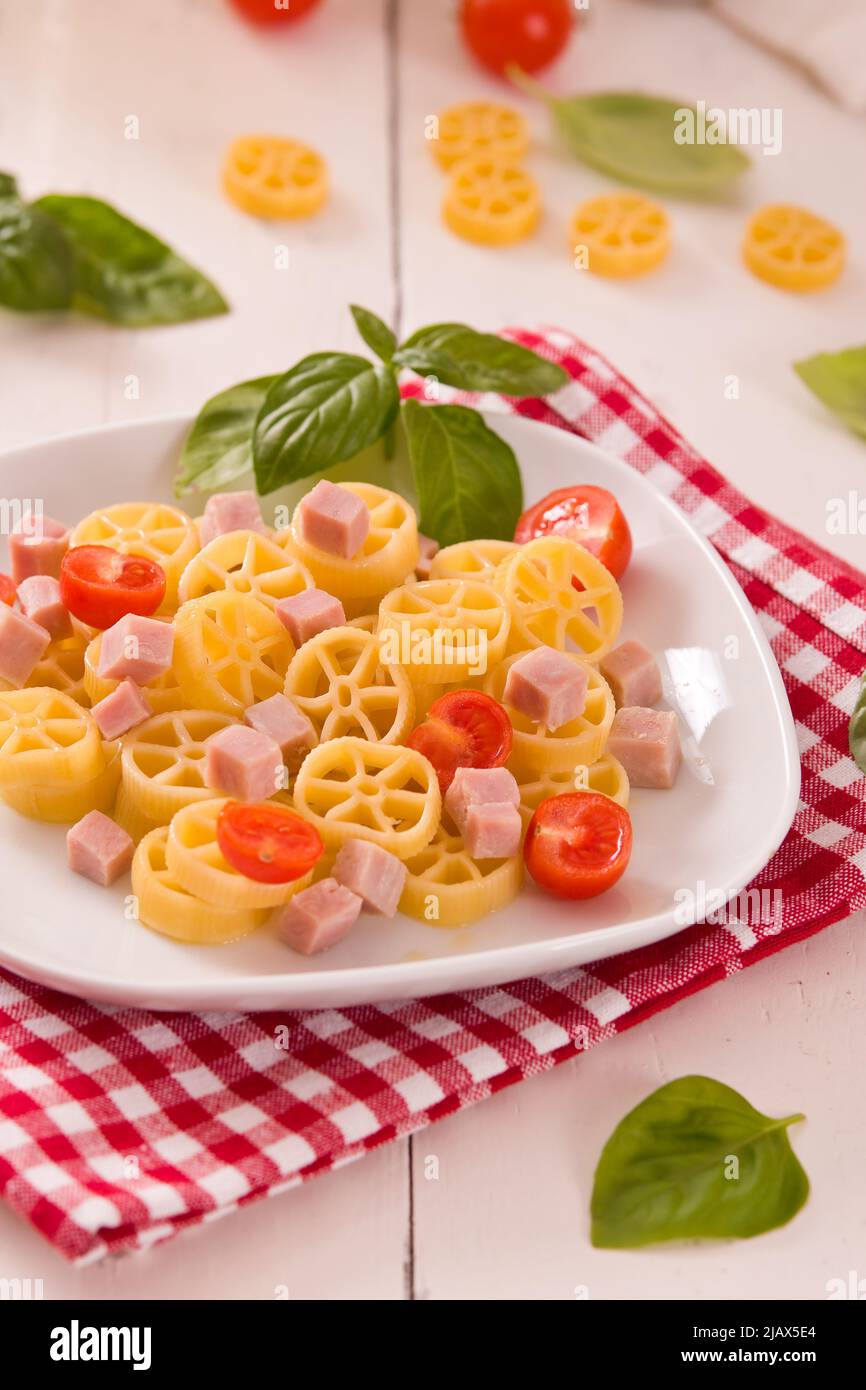 Ruote pasta with tomato and ham Stock Photo - Alamy