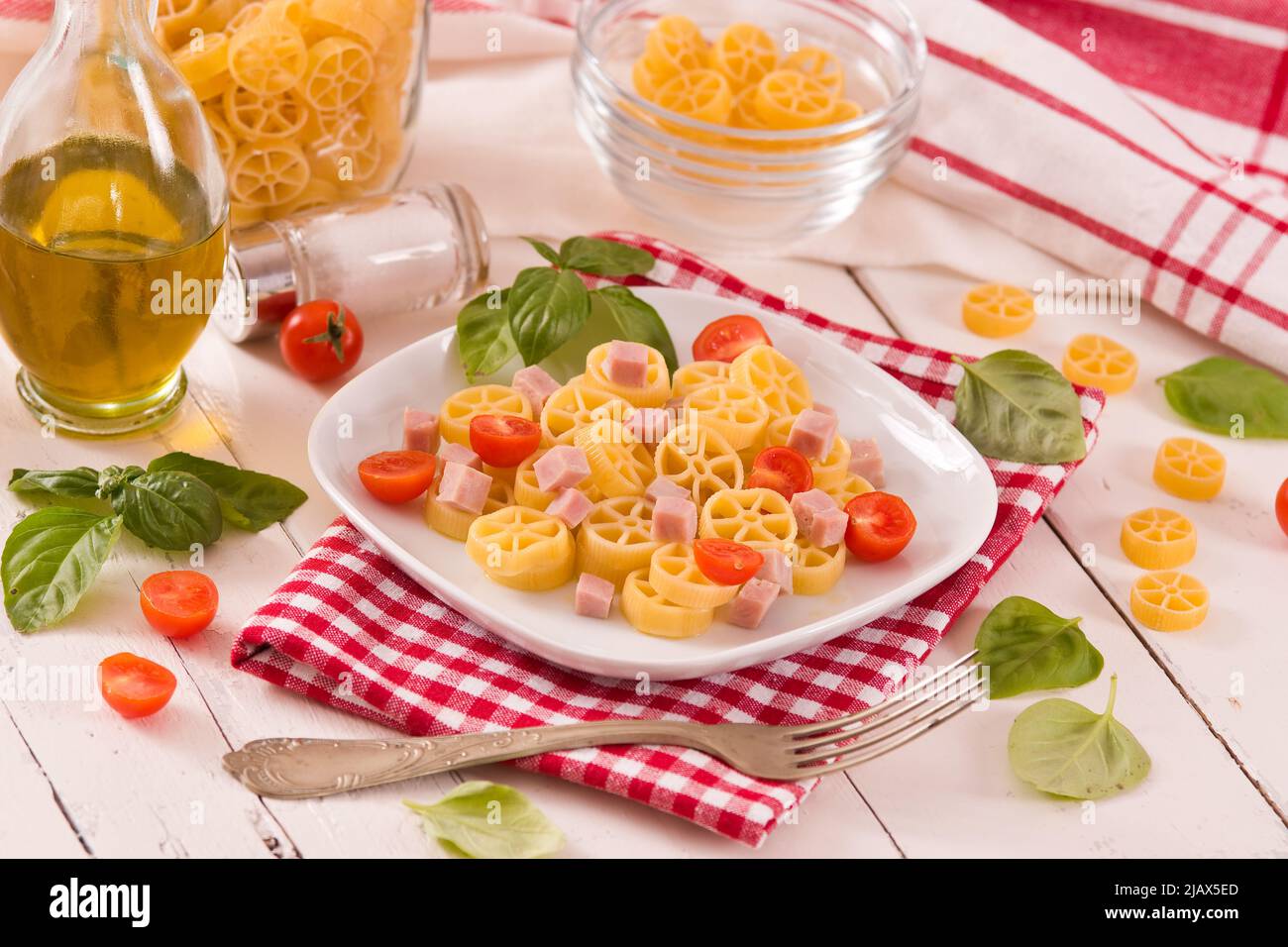 Ruote pasta with tomato and ham Stock Photo - Alamy