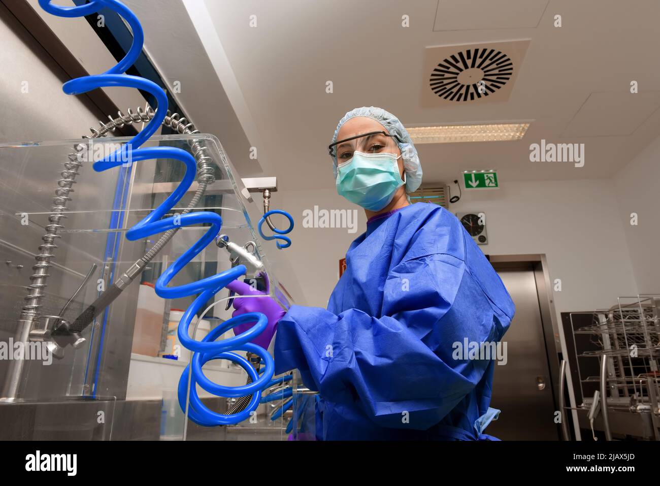 A girl works in a hospital as a medical hygiene worker. Dressed in ...