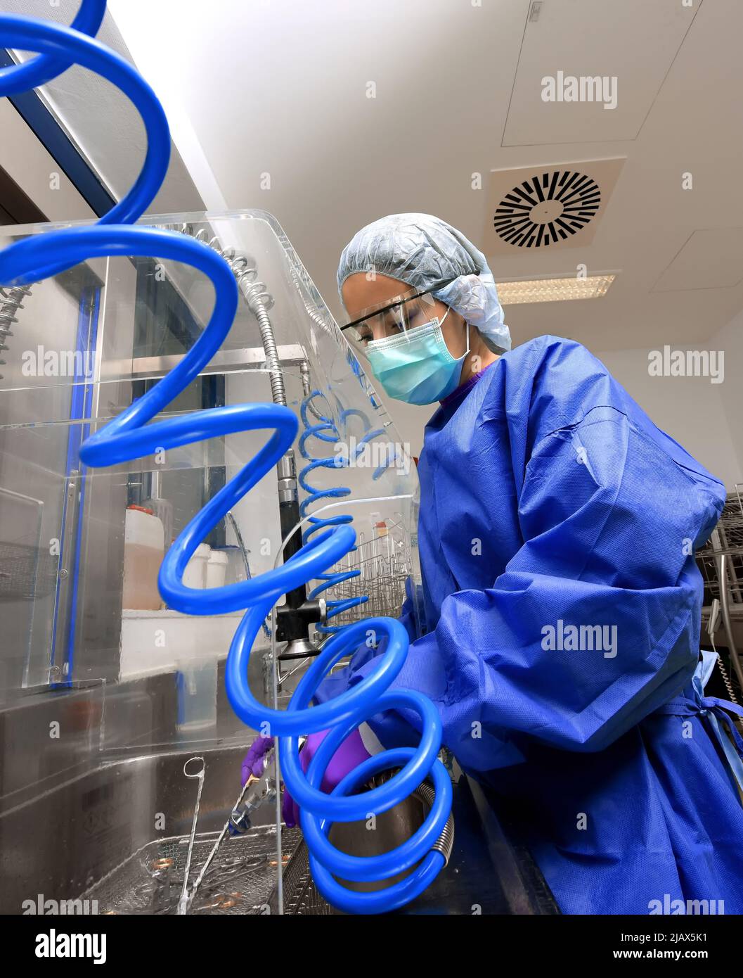 A girl works in a hospital as a medical hygiene worker. Dressed in ...