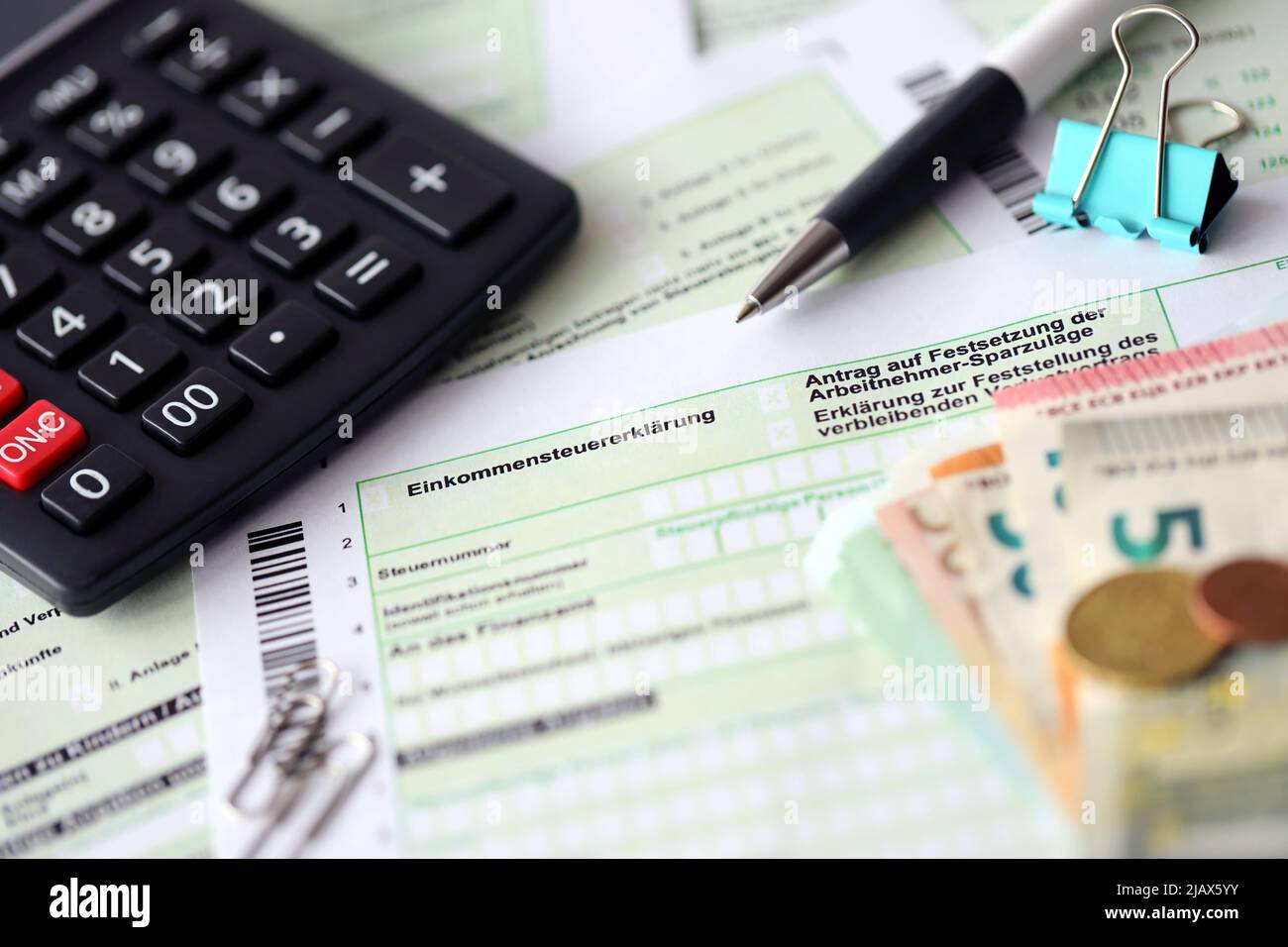 German income tax return form with pen and european euro money bills ...