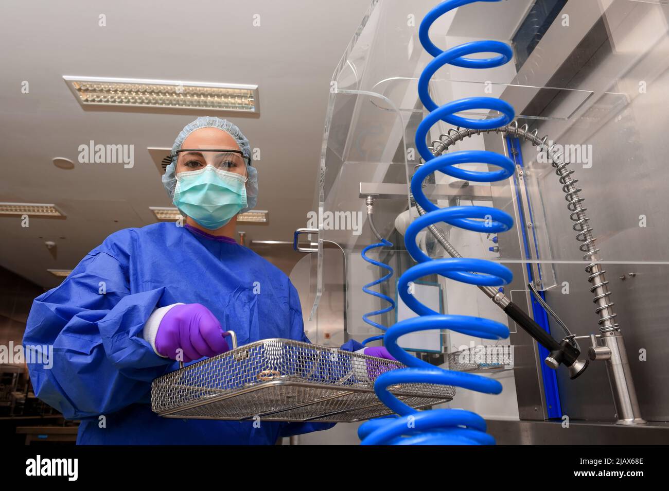 A girl works in a hospital as a medical hygiene worker. Dressed in ...