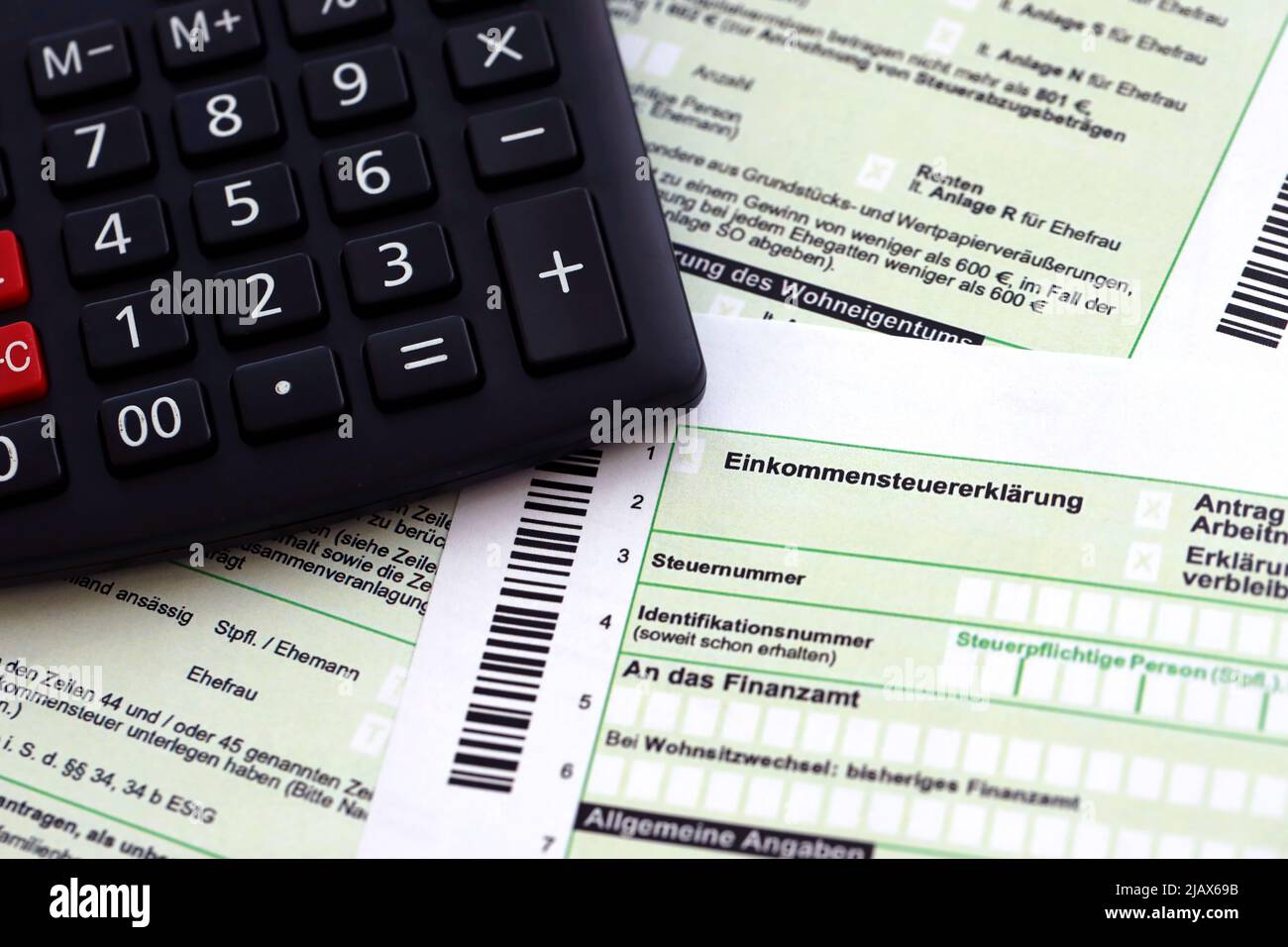 German annual income tax return declaration and calculator lies on ...