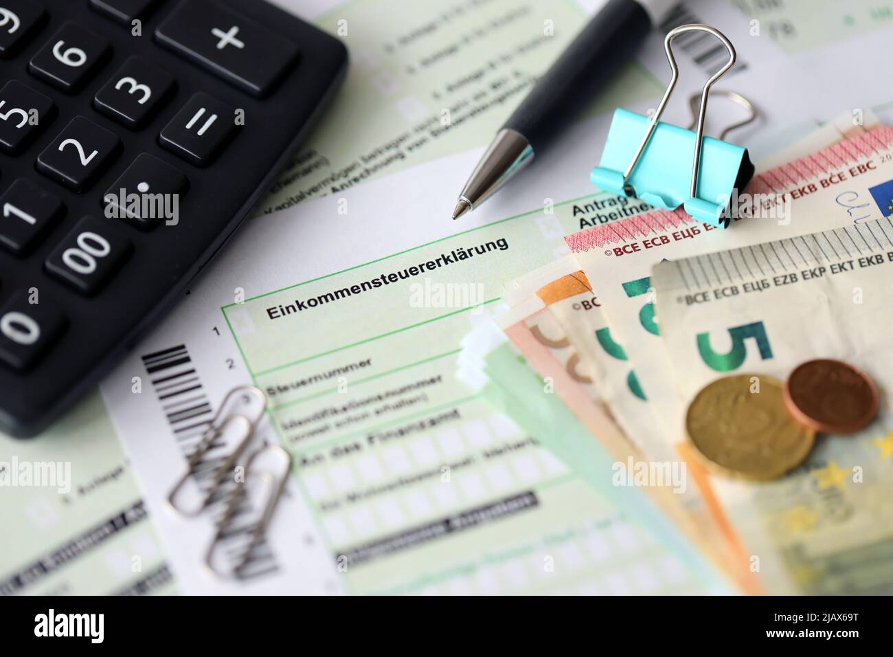 German income tax return form with pen and european euro money bills ...