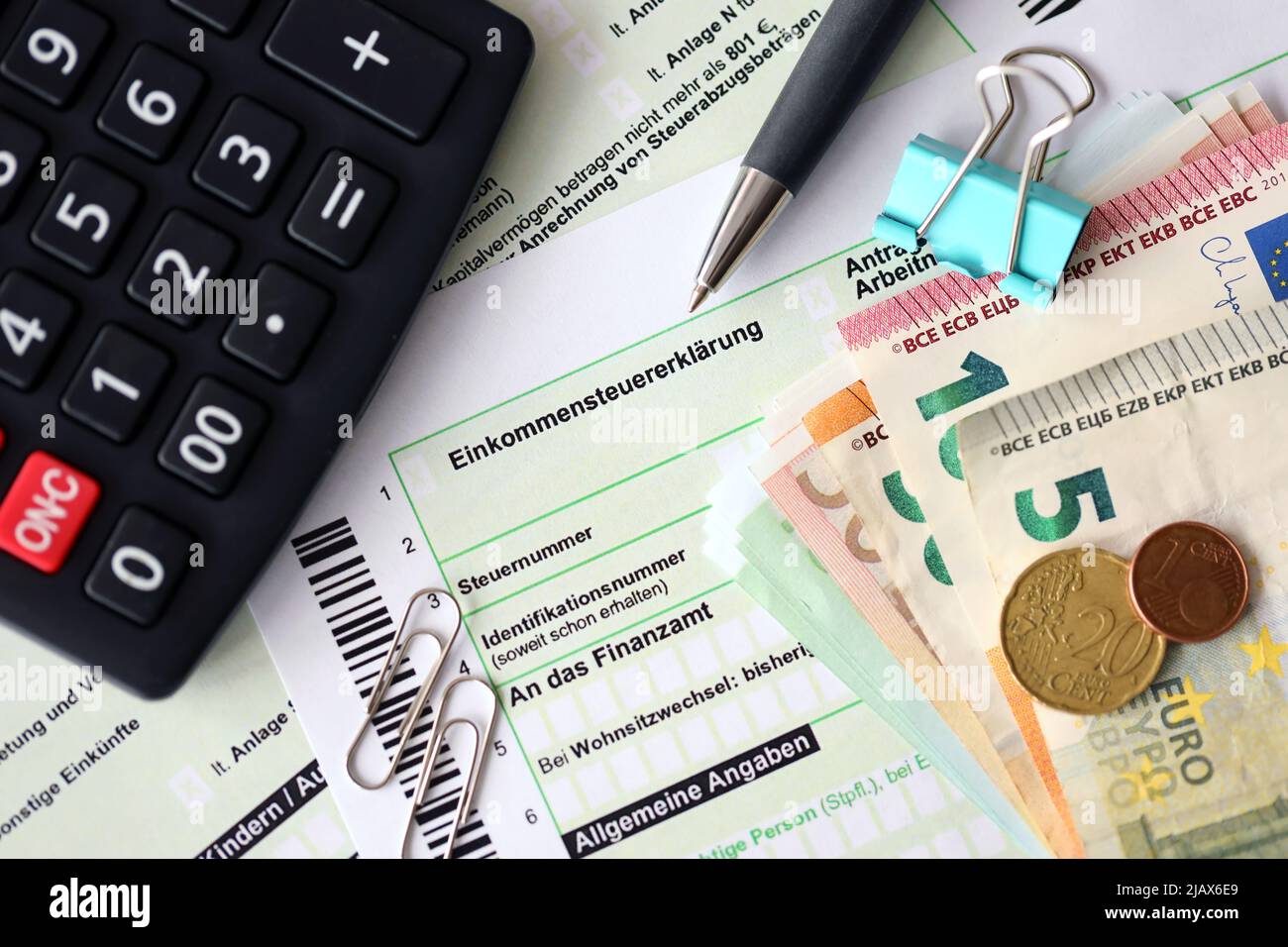 German income tax return form with pen and european euro money bills ...