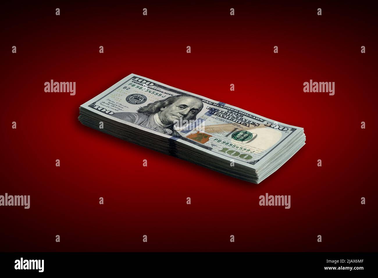 Bundle of US dollar bills on crimson red background. Pack of american ...