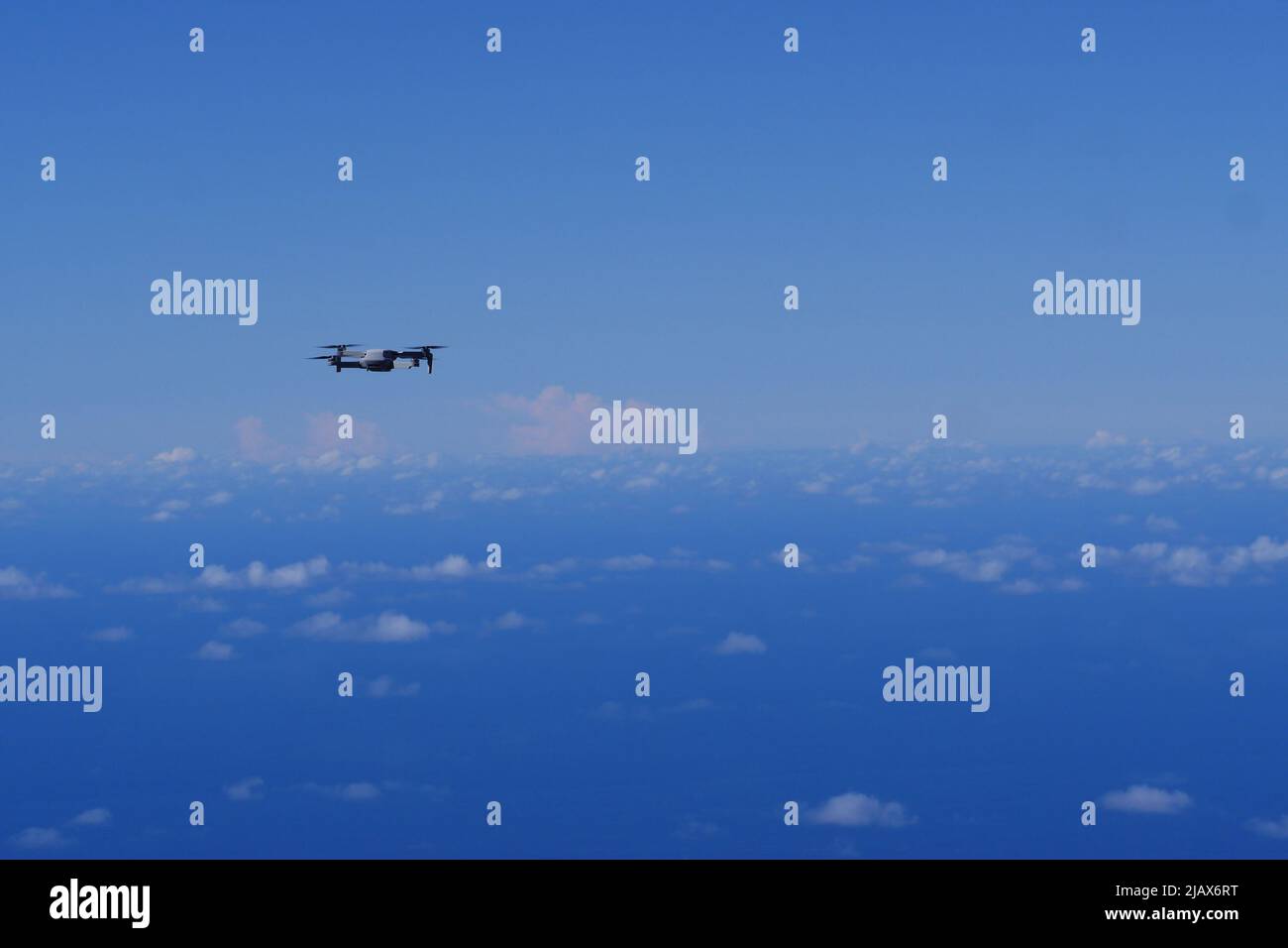 Drone protection flying during the day in blue sky Stock Photo - Alamy