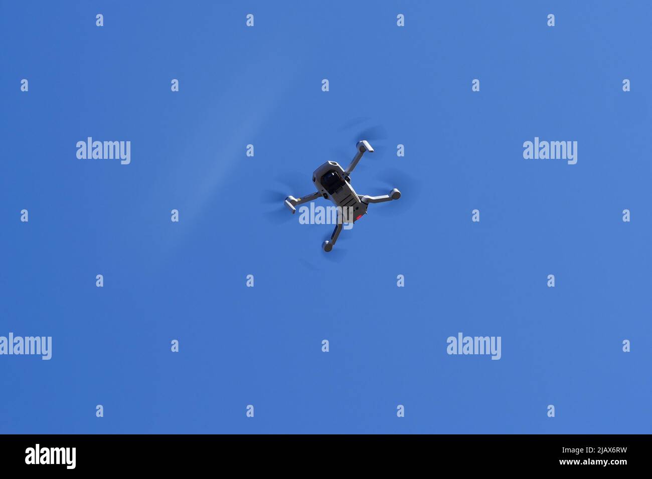 Drone protection flying during the day in blue sky Stock Photo - Alamy