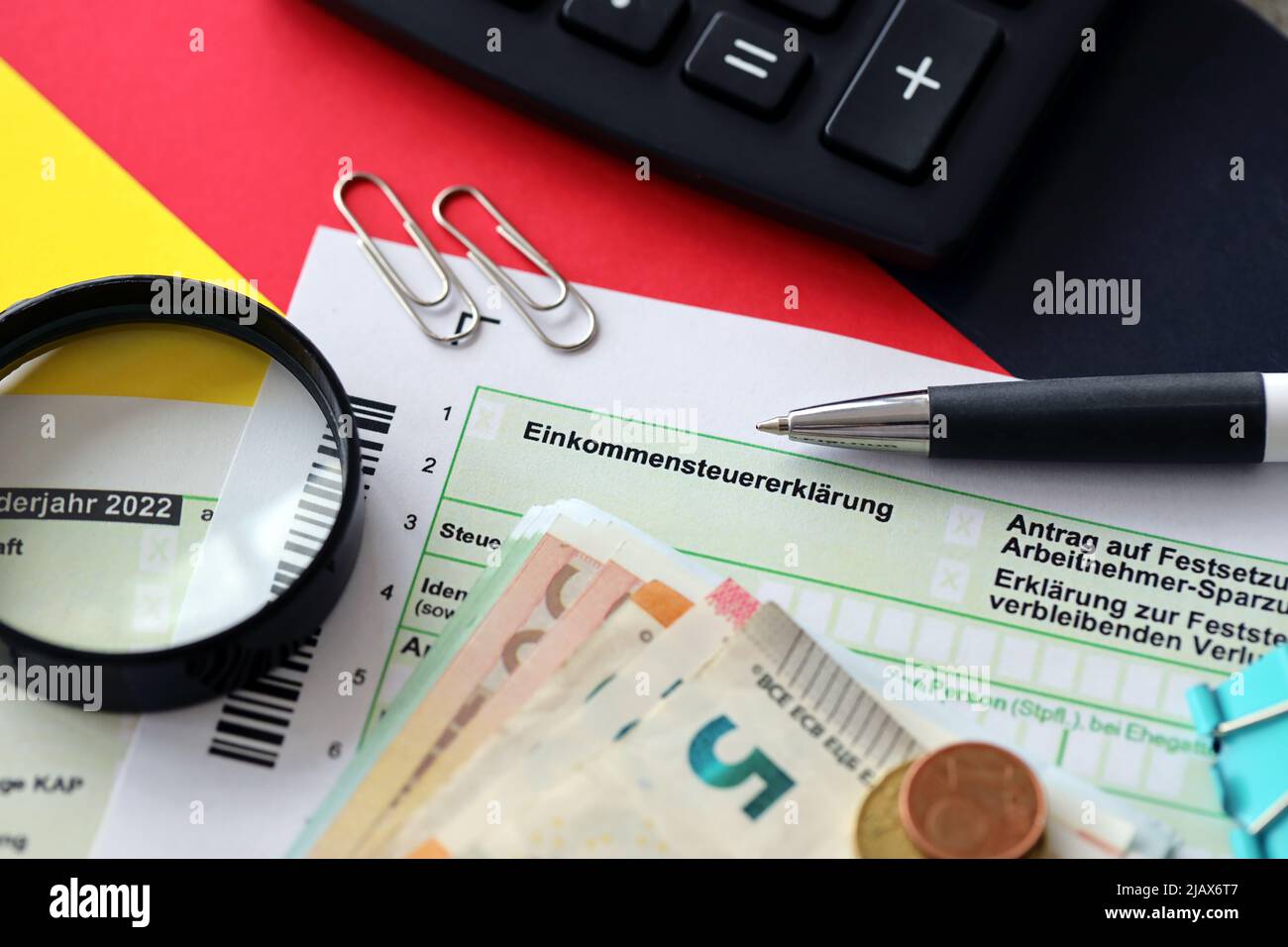 German income tax return form with pen and european euro money bills ...