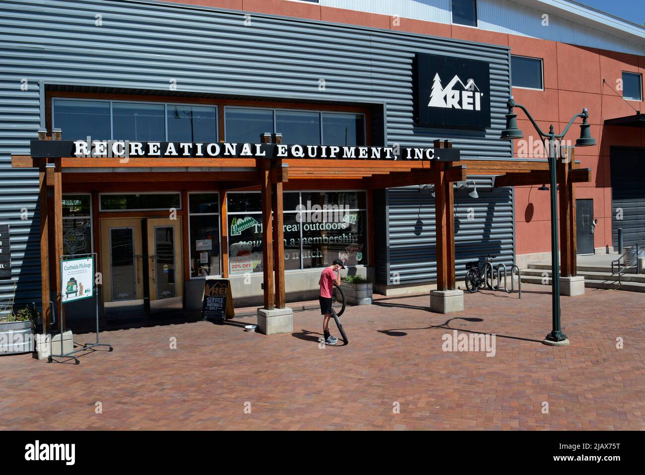 A customer exits an REI (Recreational Equipment, Inc.) store in Santa ...