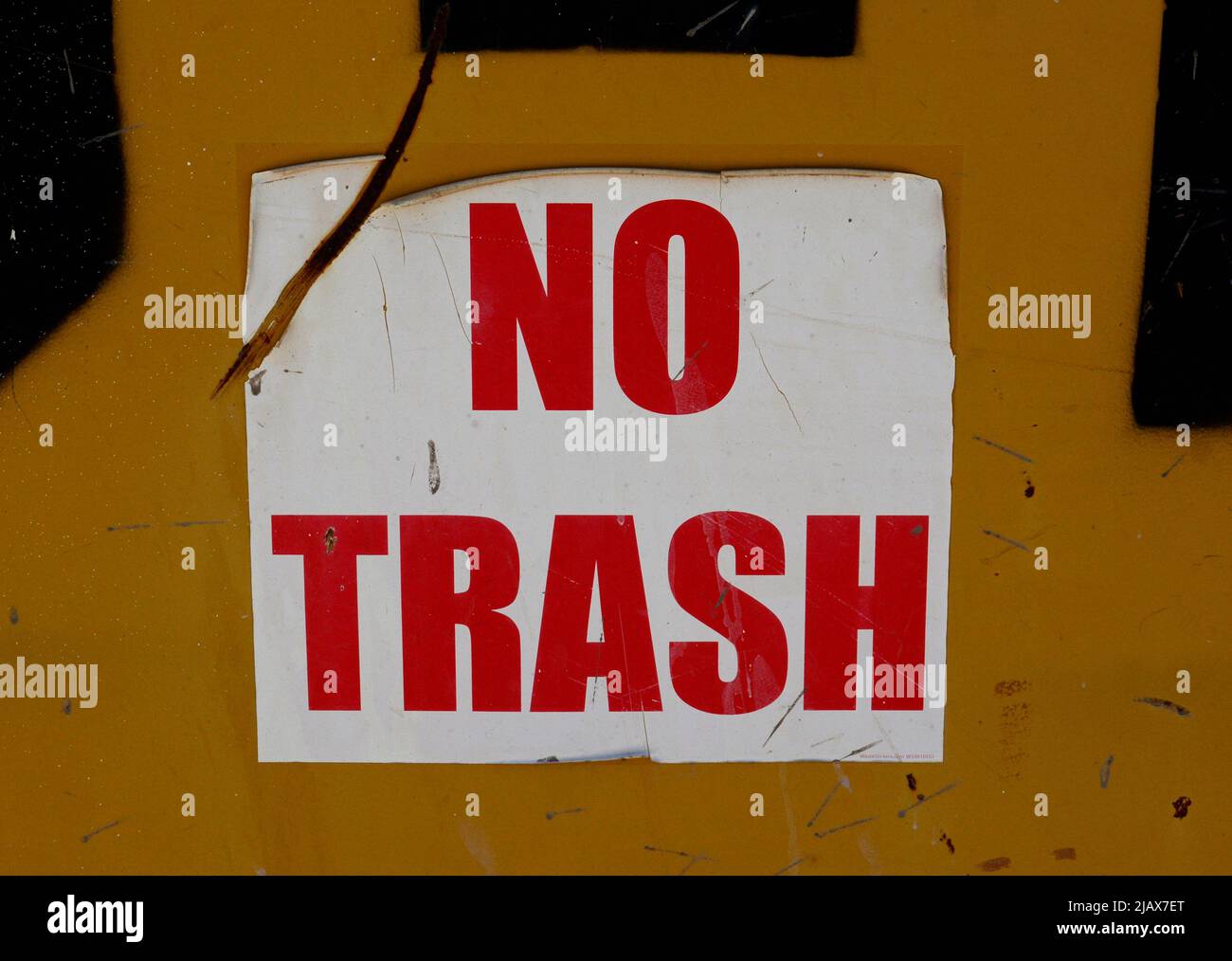 A "No Trash" sign on the side of a rentedl trash dumpster at a ...