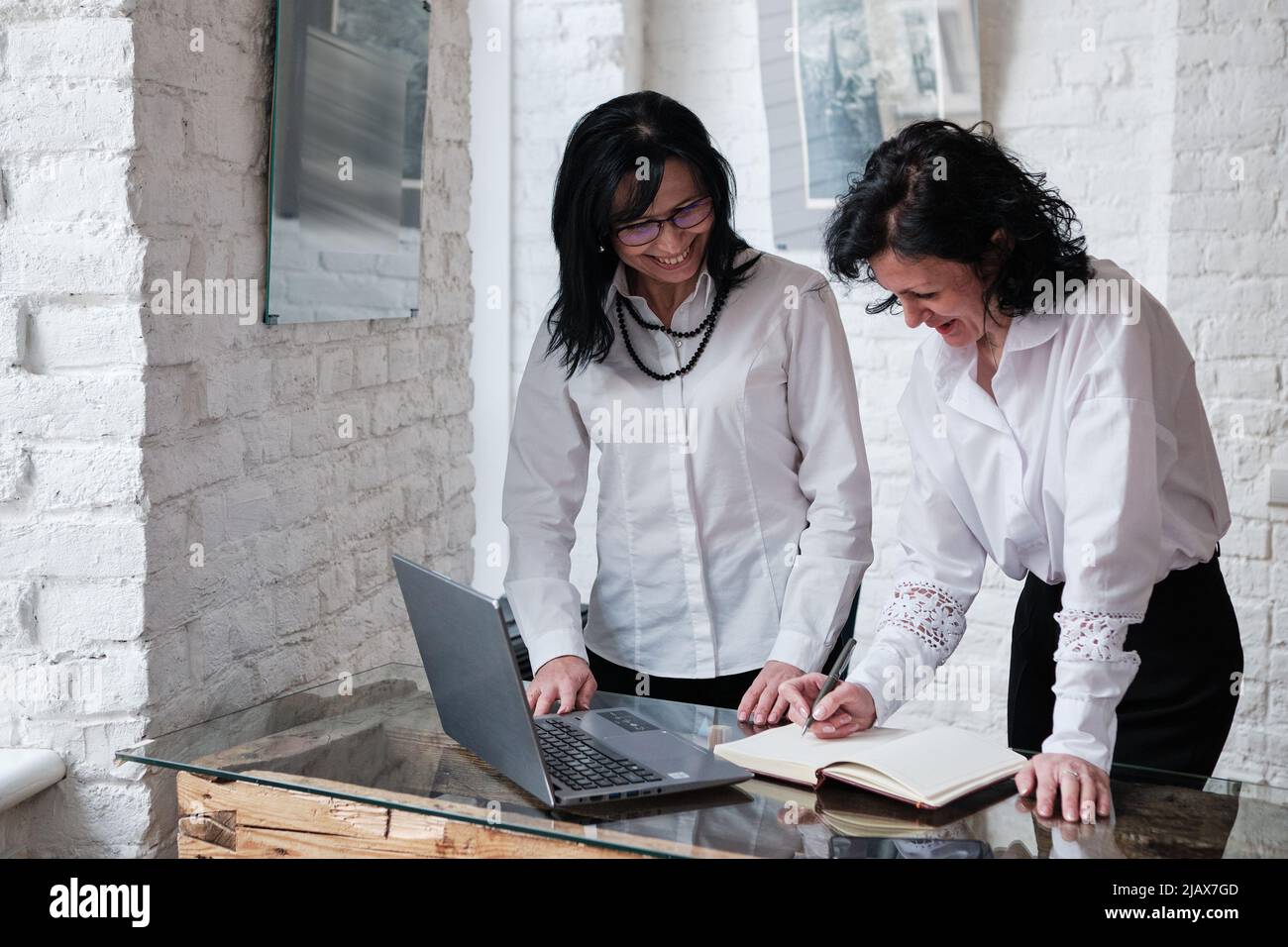 Two business women talking and working together. Teamwork, Business Communication. Start Up ...