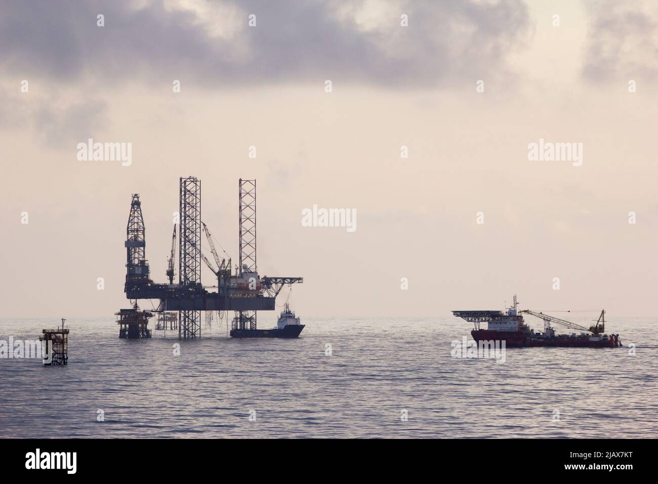 Oil rigs with supply boat boat for transporting people or materials to ...