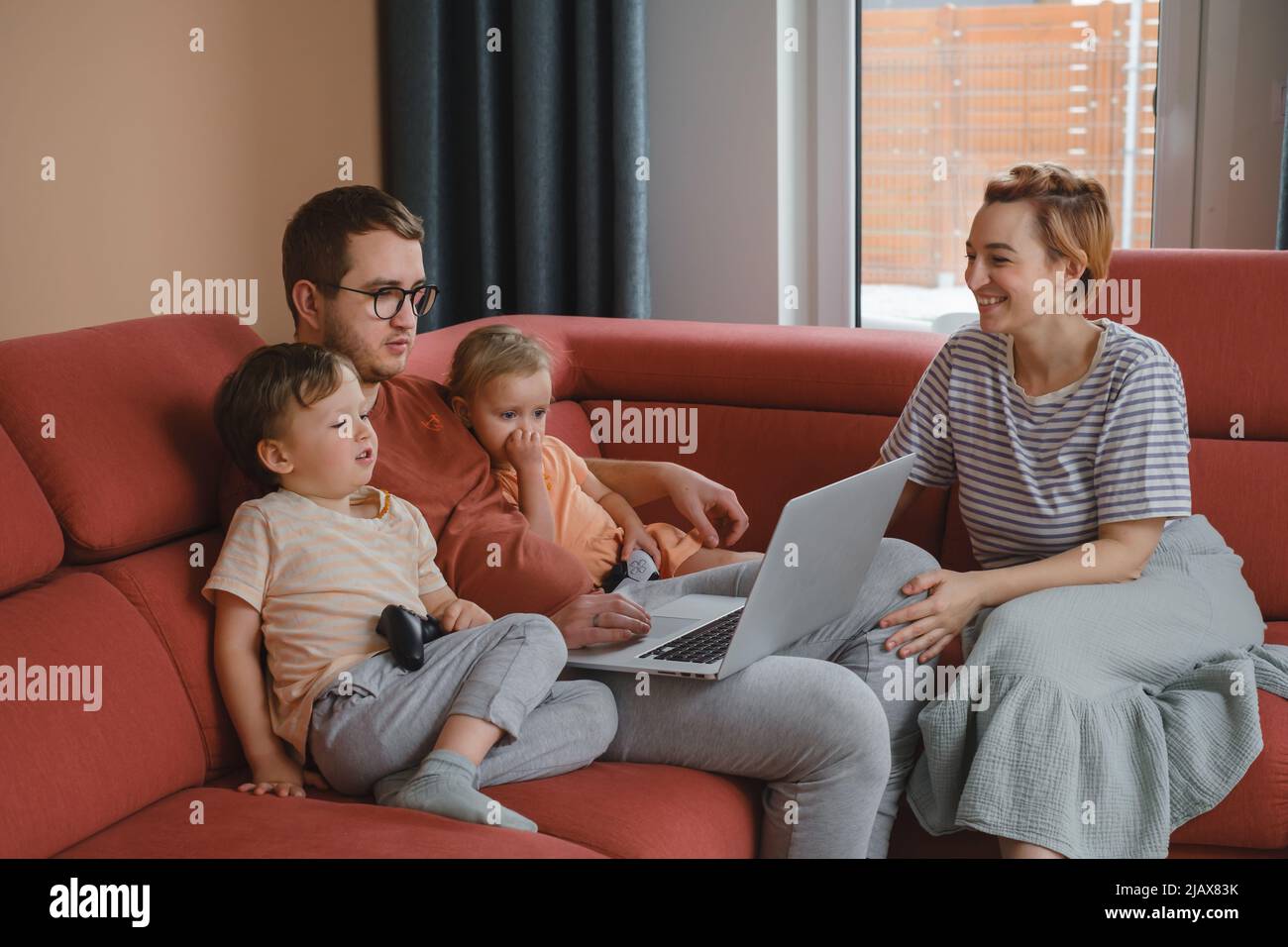 Big happy family watching movies playing games on laptop. Mother father ...